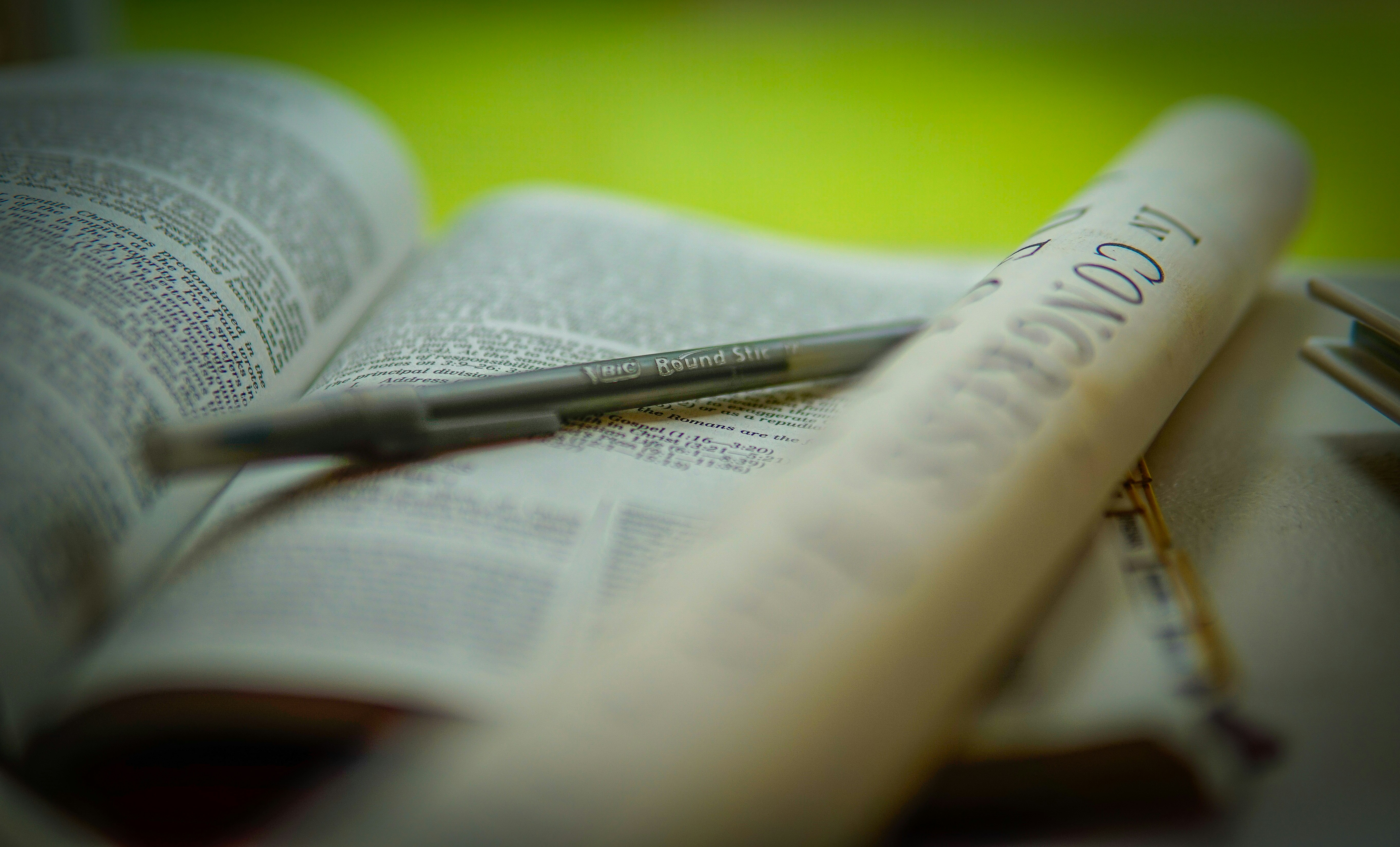 Ink and Light: A Close-Up of a Rolled Journal over an Open Book