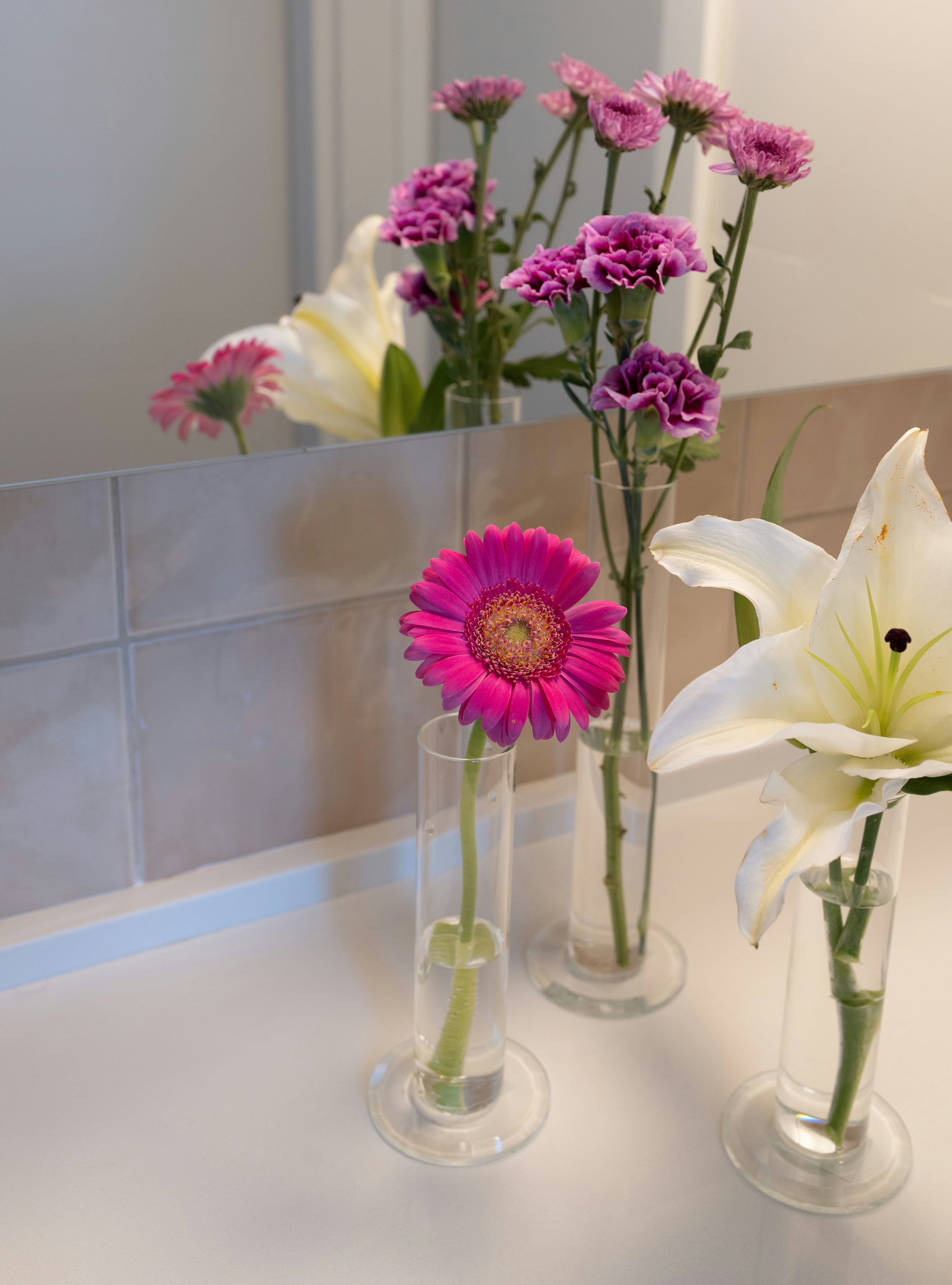Pink Gerbera and White Lily Bloom in a Minimalist Bathroom Still Life