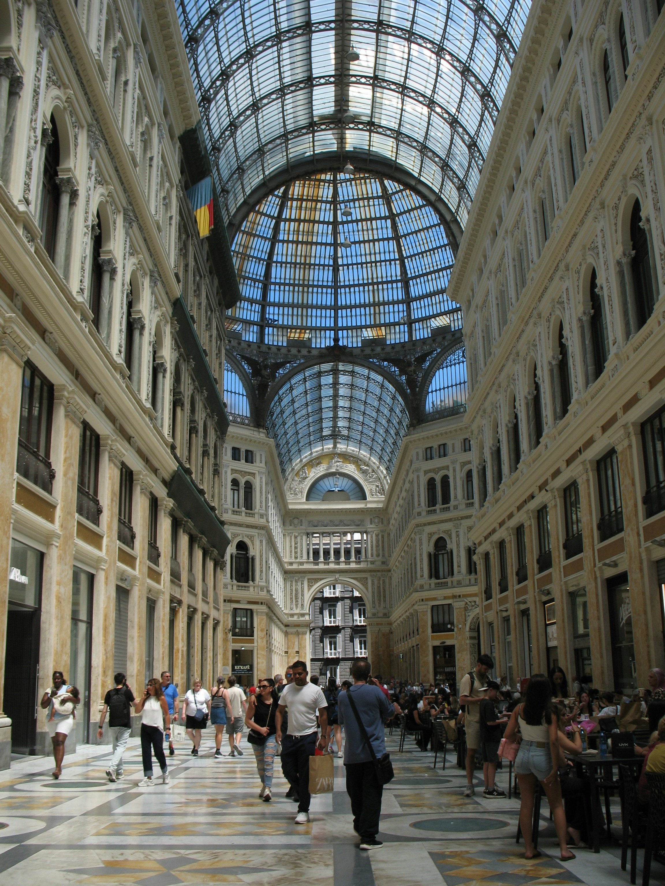 Vaulted Glass and Footsteps: A Busy Marble Hall Beneath a Skyward Metropolis