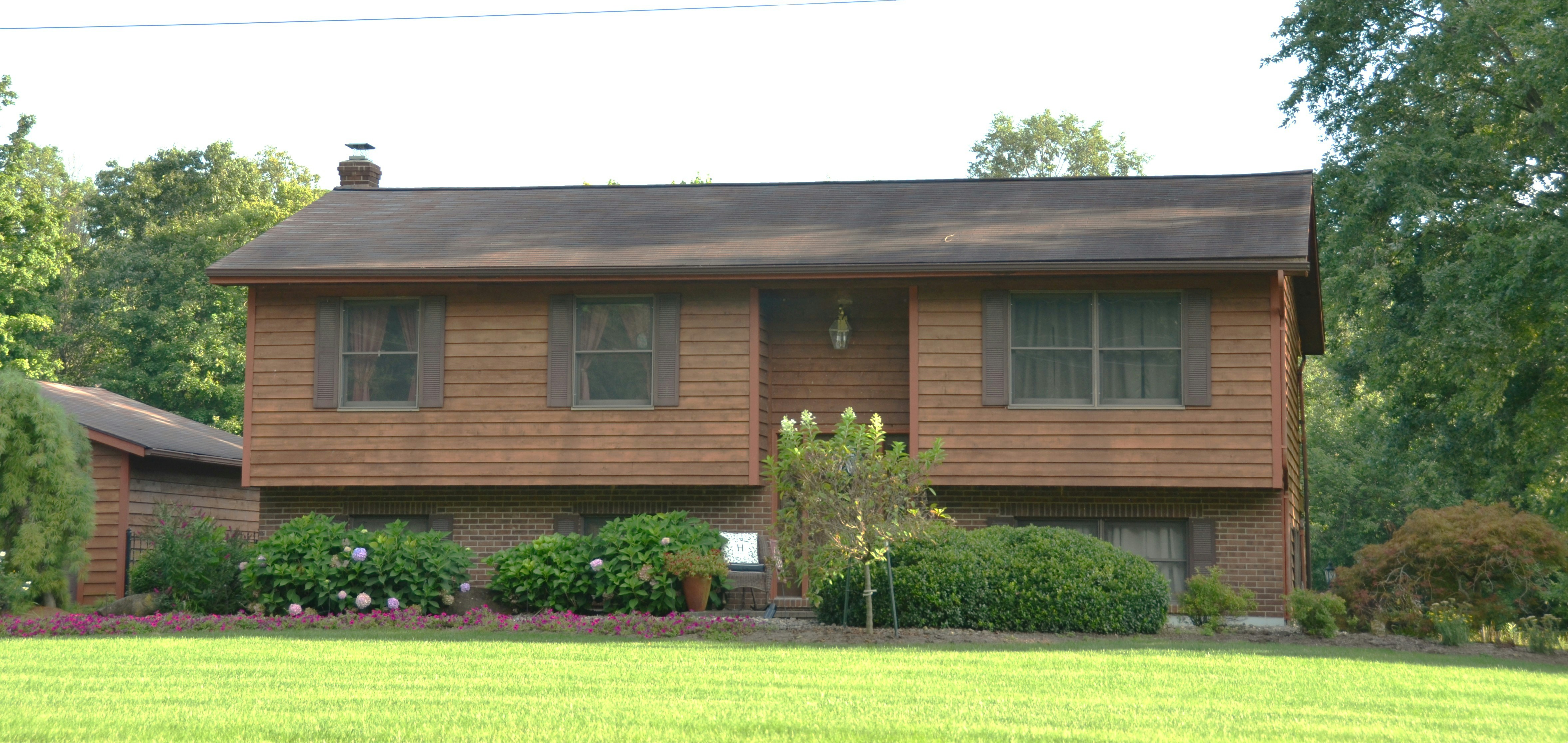 Mid-Century Suburban Facade: A Quiet Green Front Lawn and Brick-Framed Home