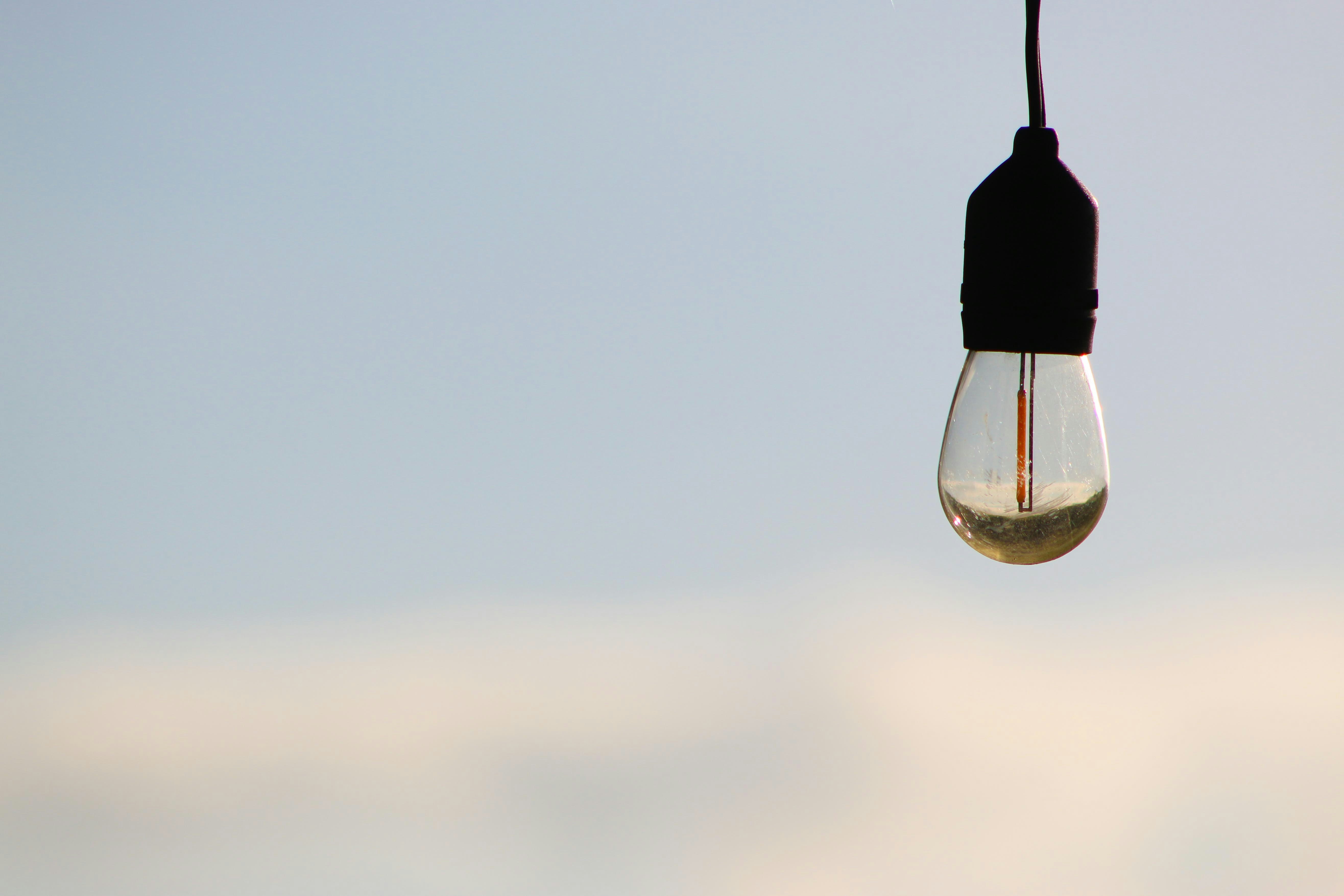 A Lone Filament: The Hanging Light Against an Open Sky