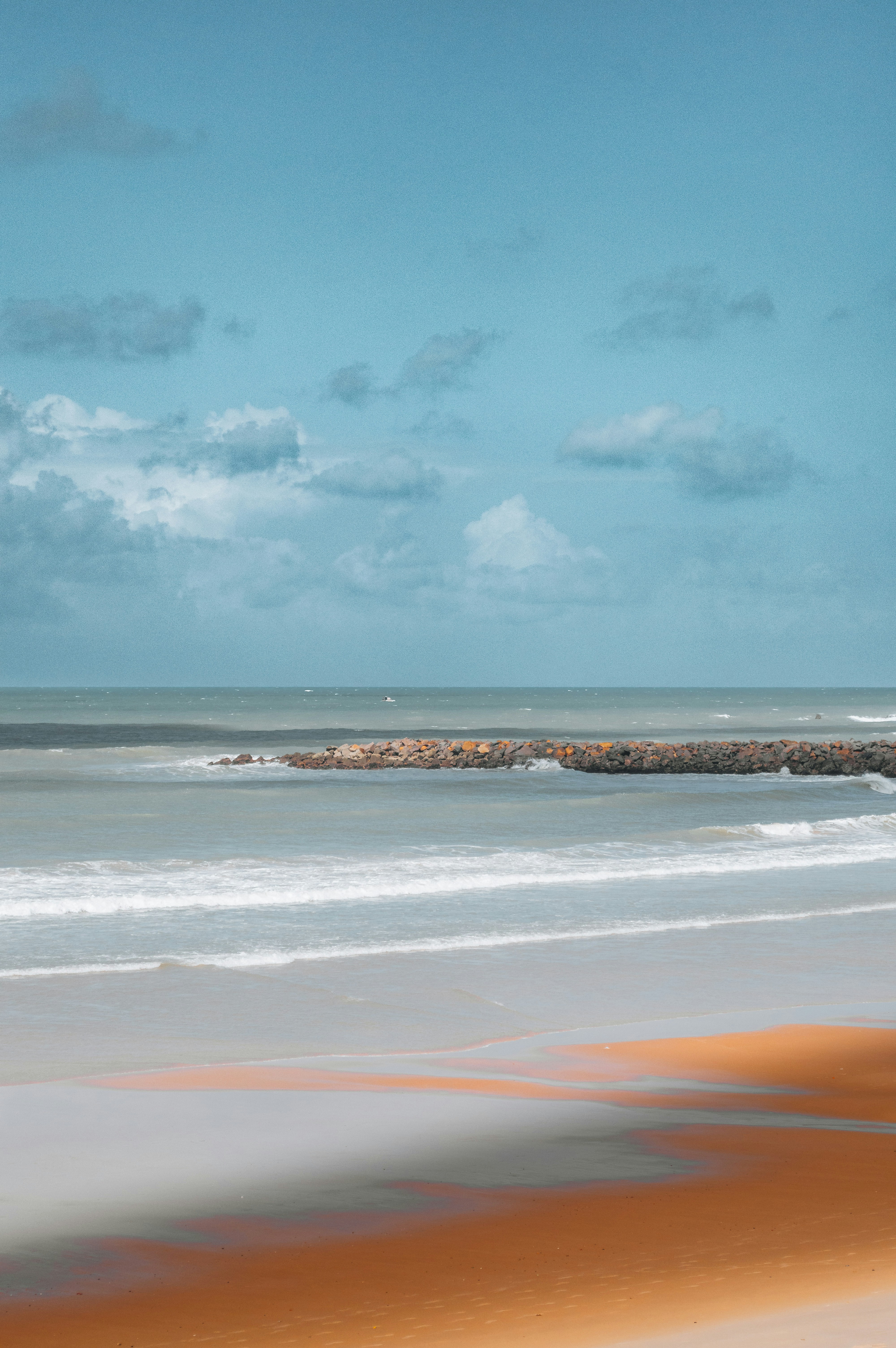Coastal Serenade: Sand, Sea, and Sky in Soft Light