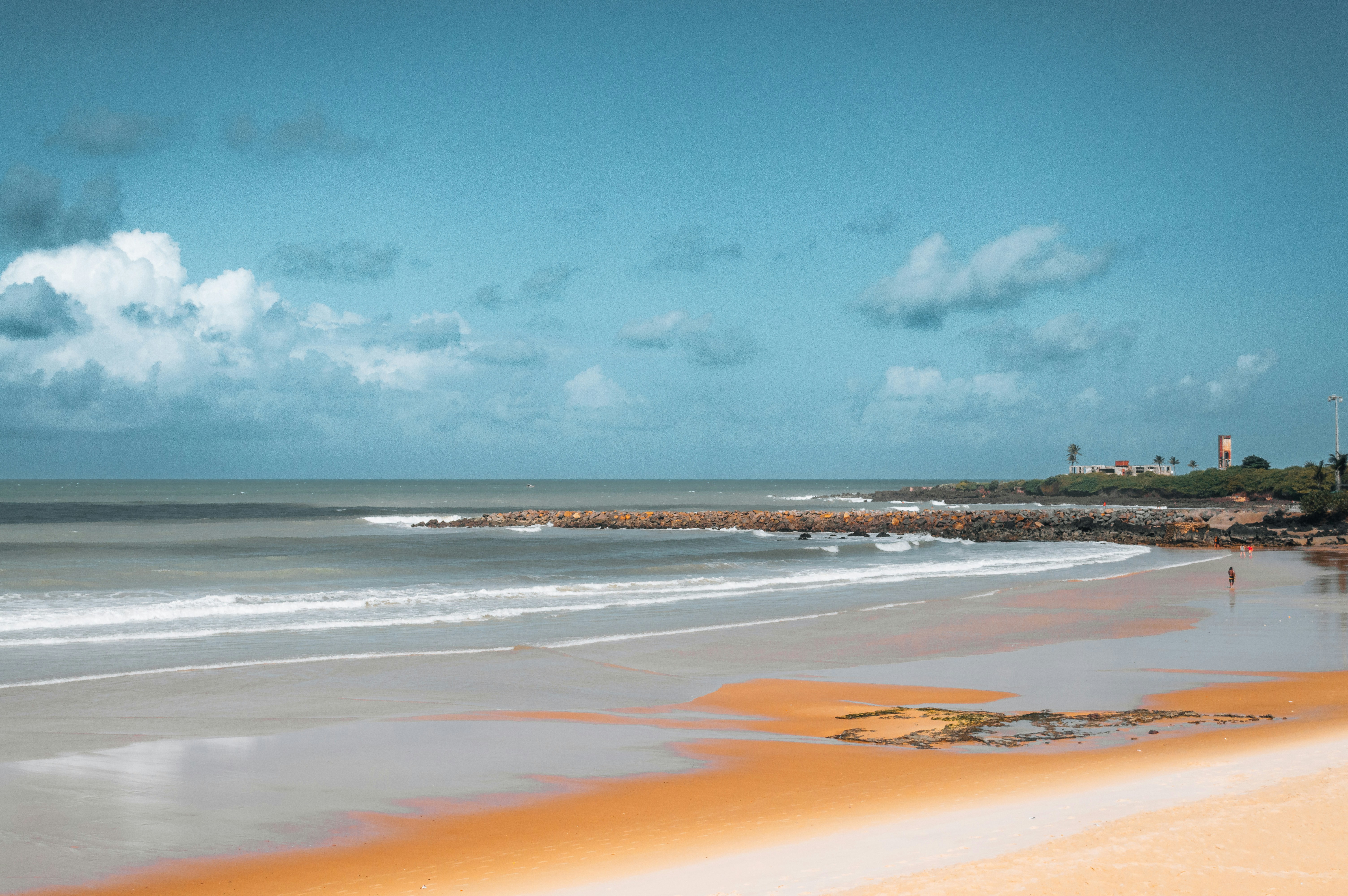 Coastal Horizon: Beach, Ocean, and Distant Play of Light