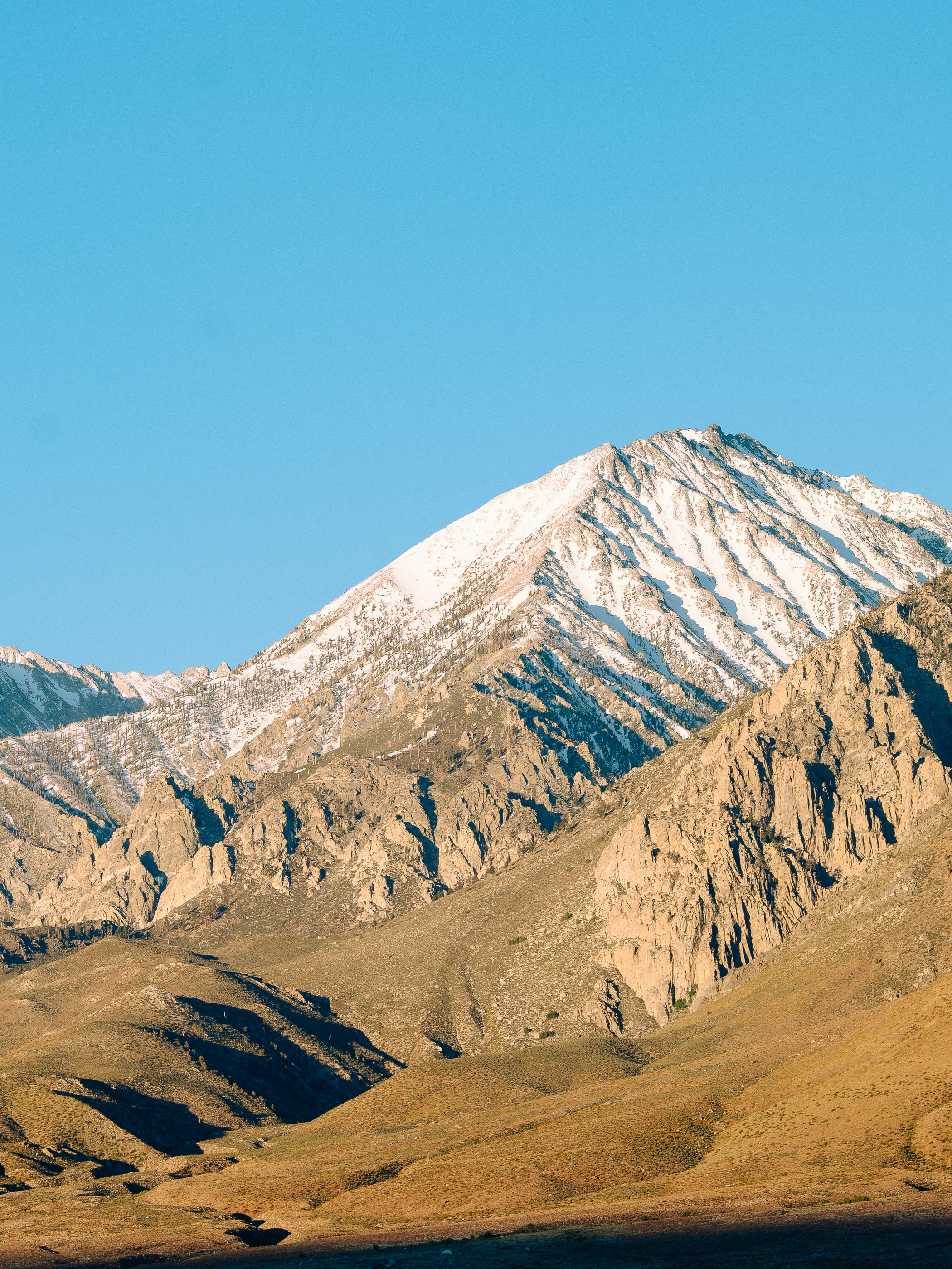 Snow-capped Peak Bordered by Sunlit Valleys
