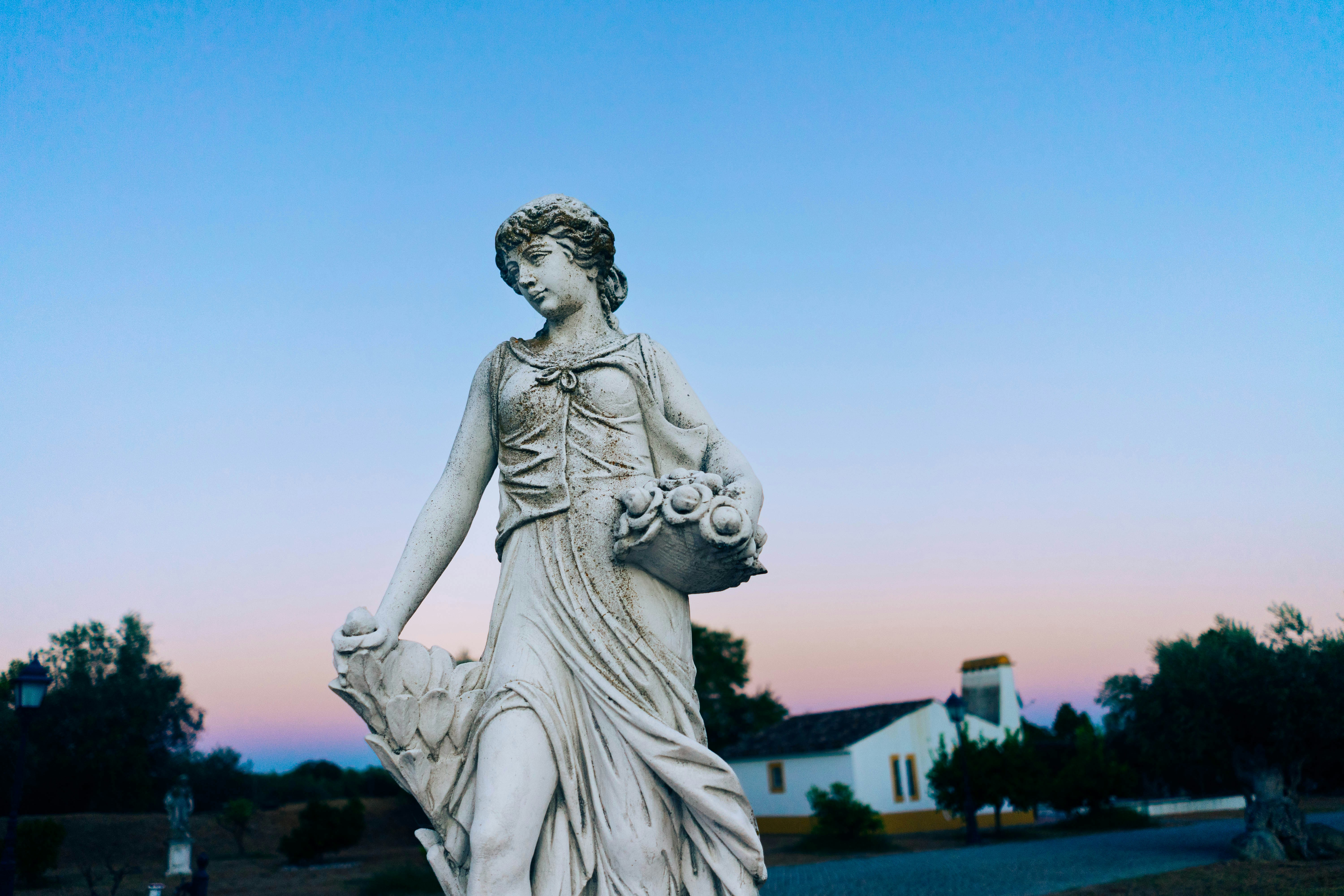 Statue of Elegance: A Classical Figure Against a Pastel Twilight