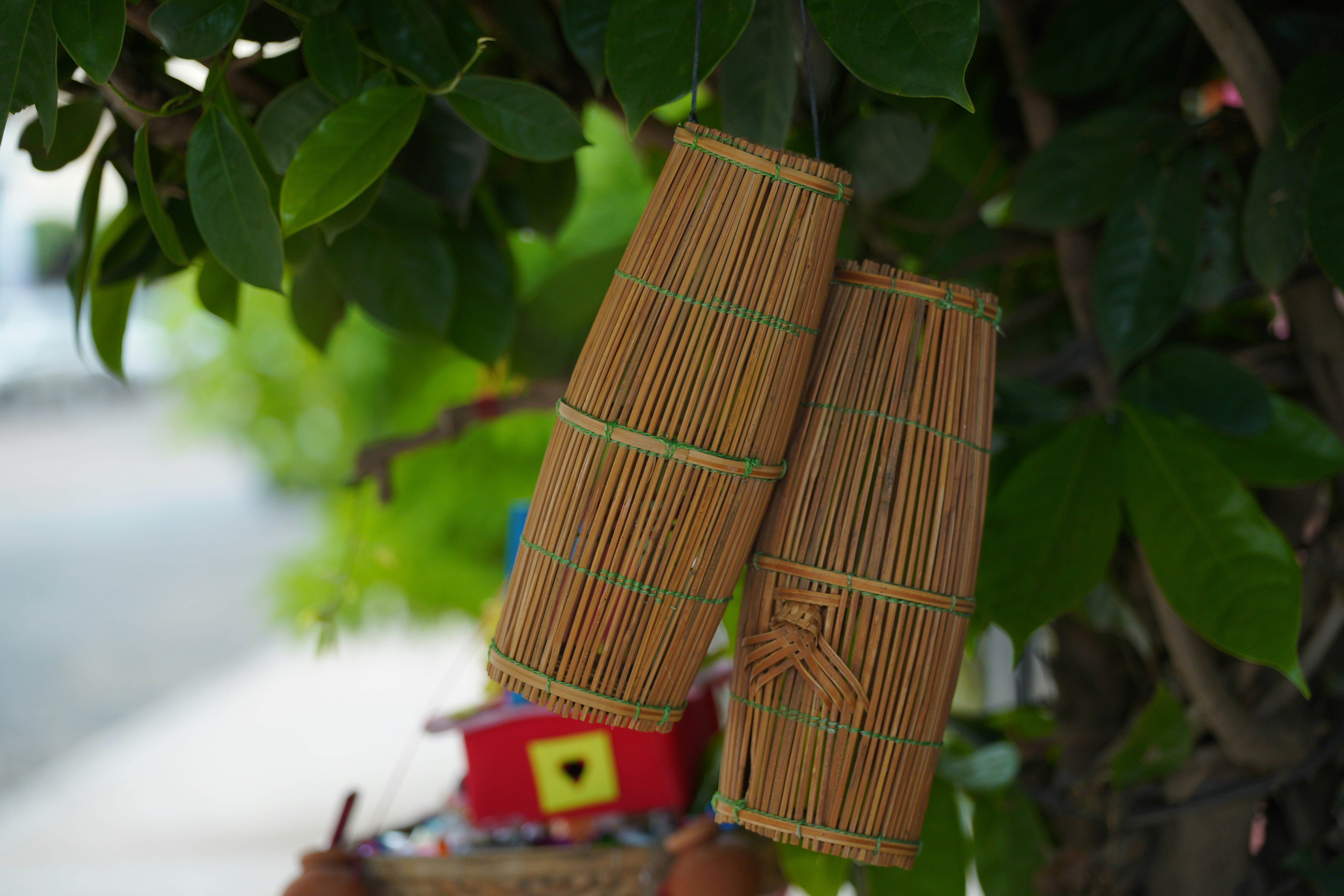 Stitched Cedar Lanterns Amid Green Canopy
