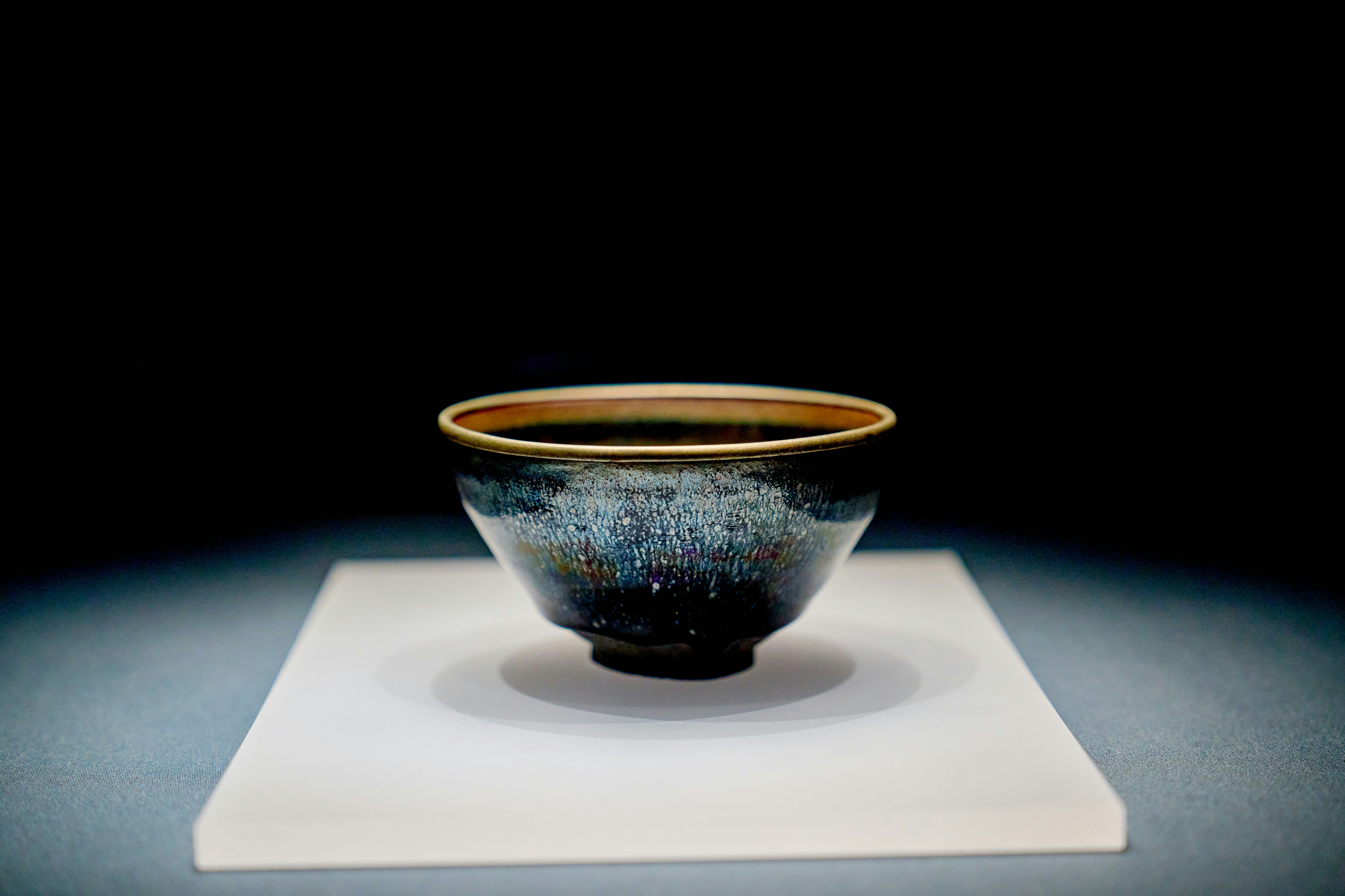 Ceramic Vessel Centered in a Spotlight of Quiet Gallery Light