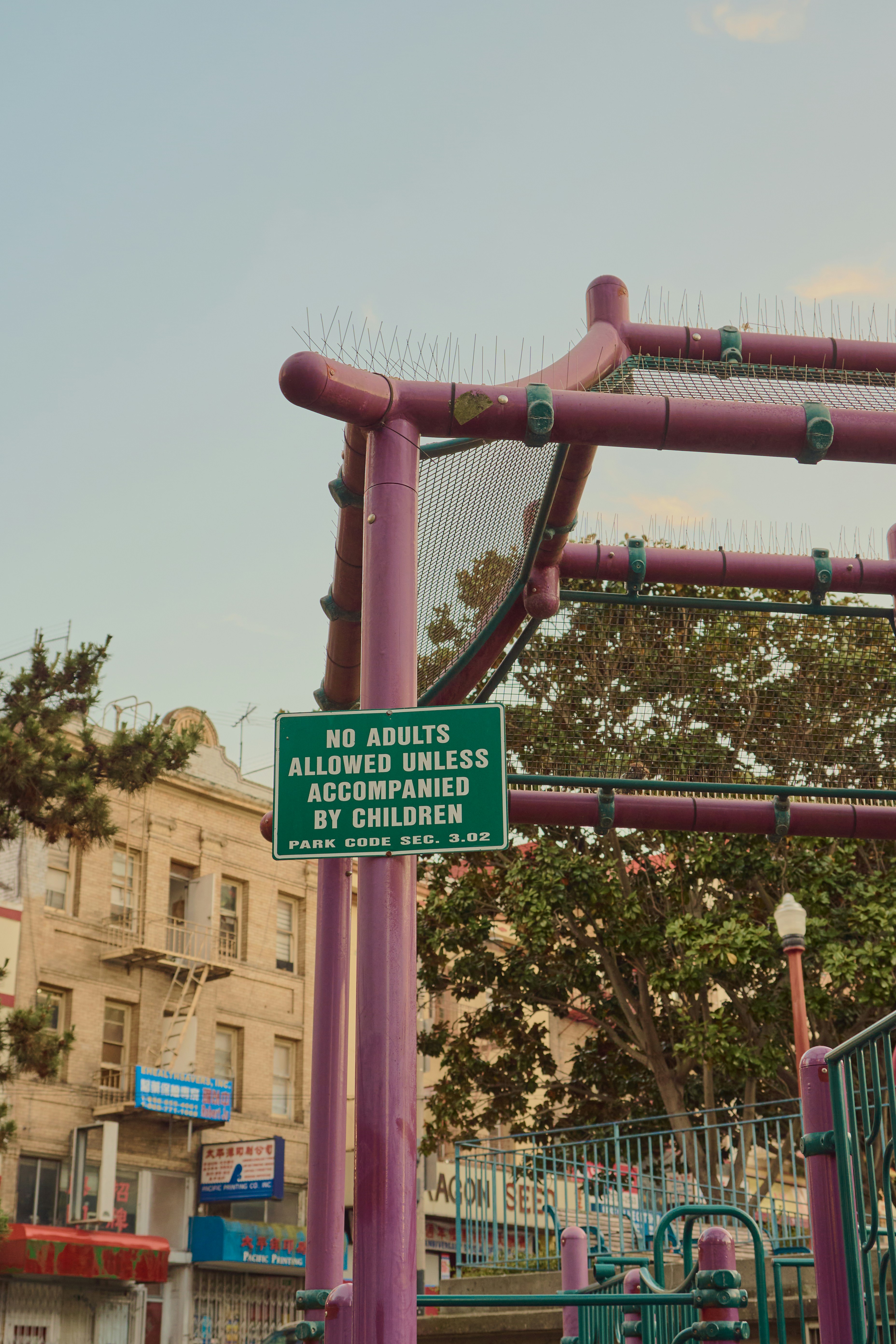 Playground Signage Under a Purple Structural Arc