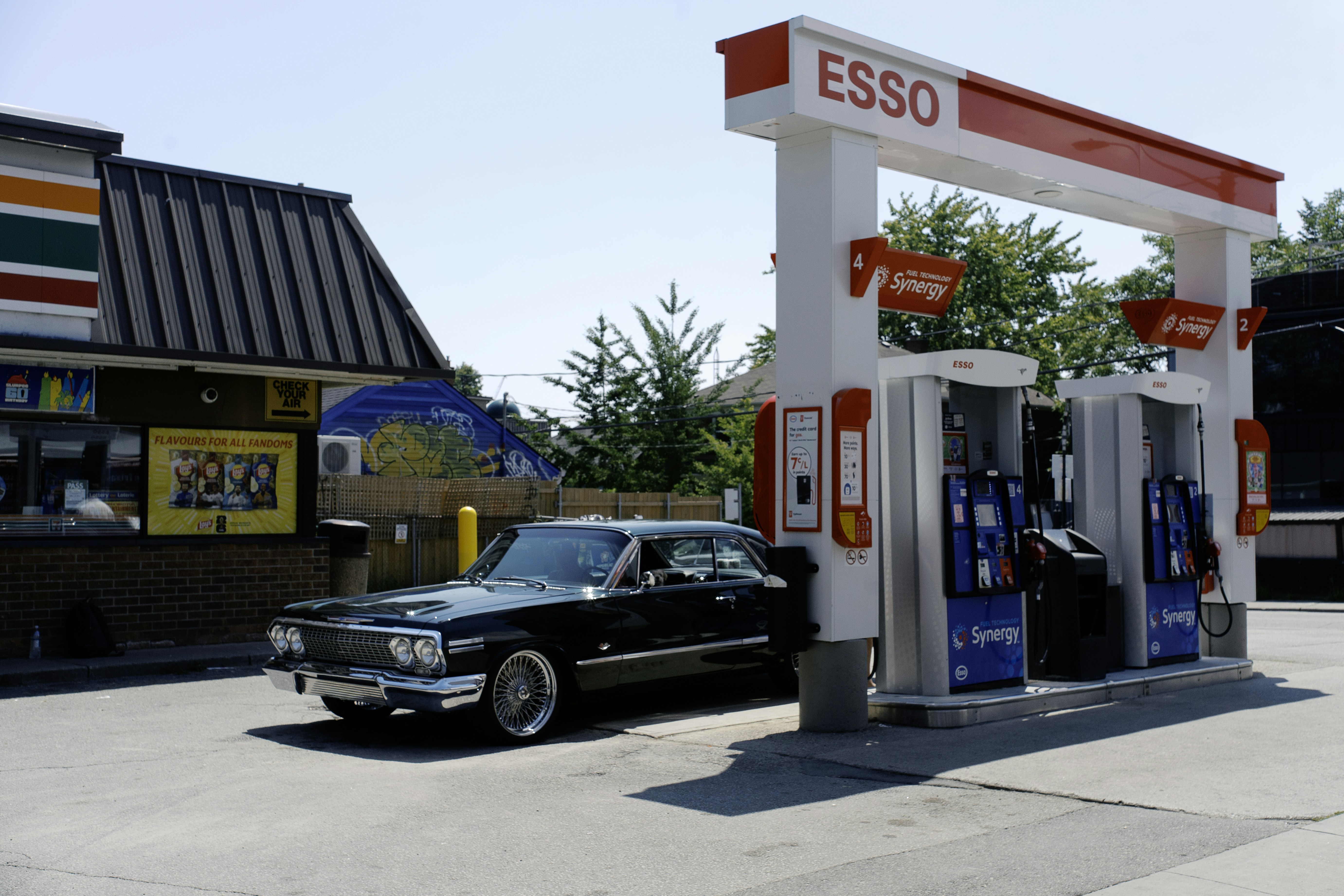 Midcentury Sedan at a Quiet Esso Stop
