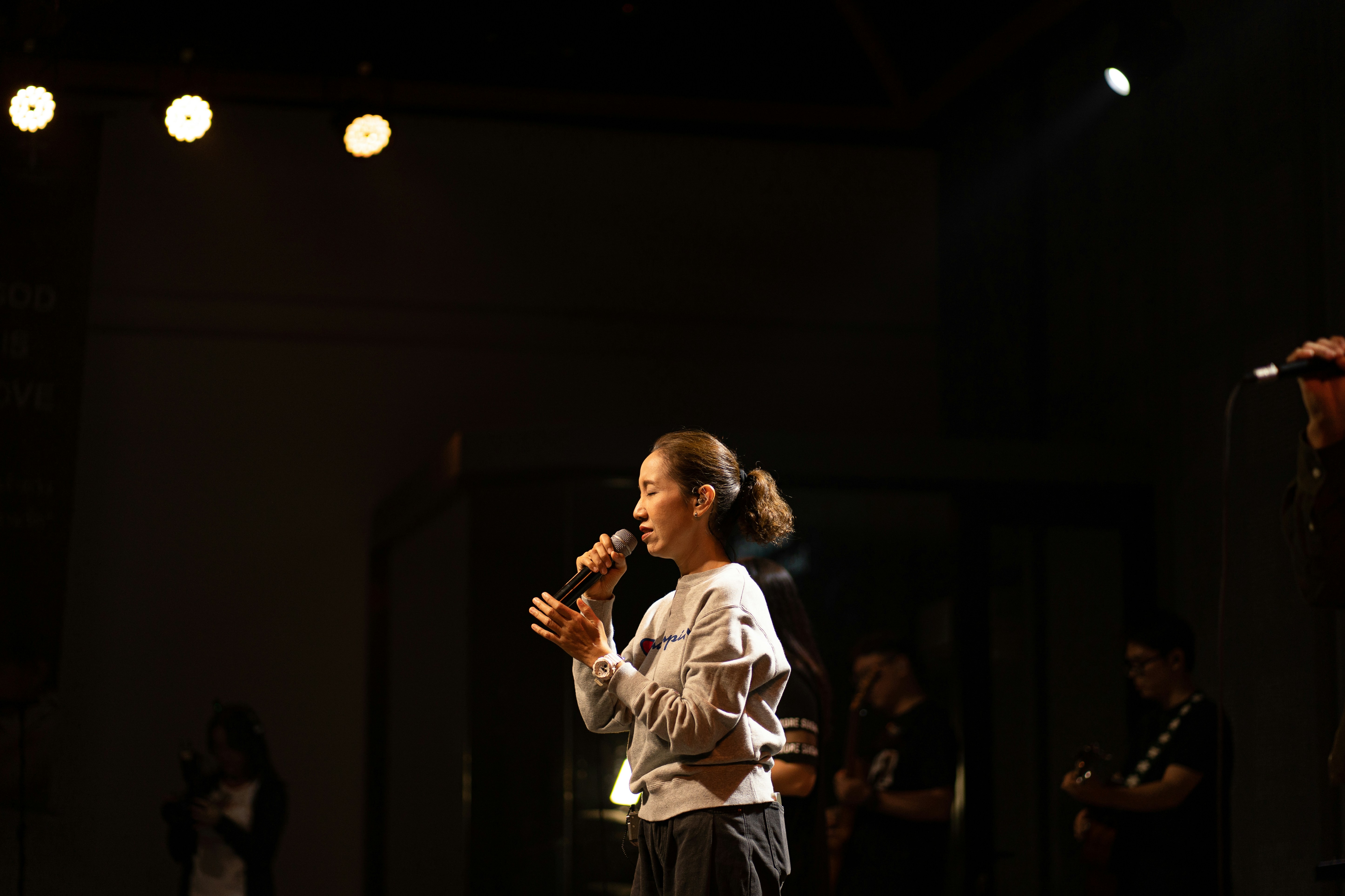 Vocal Spotlight: A Solo Singer in a Dim Stage