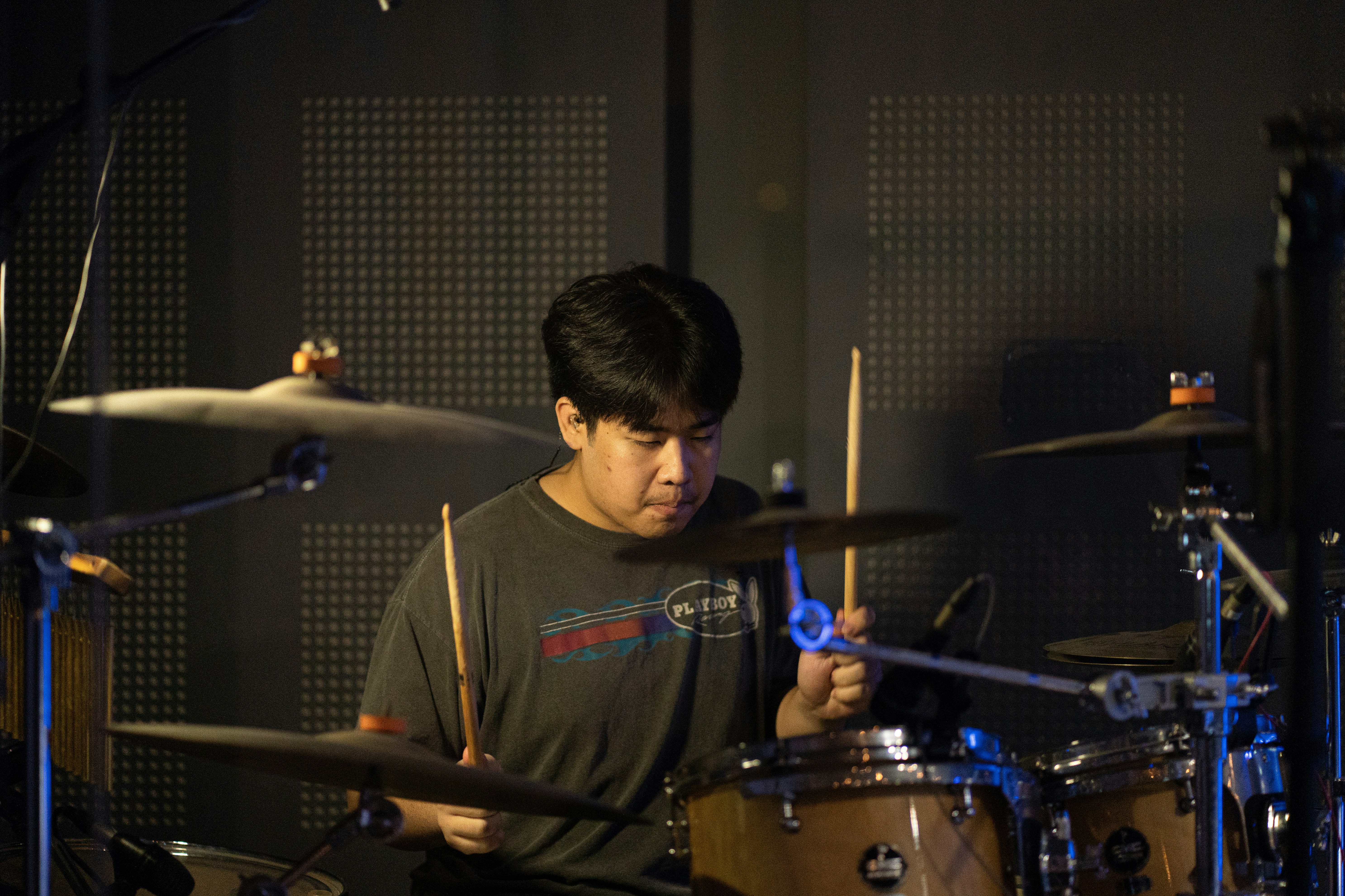 Midnight Groove: Drummer in Focus Behind the Kit