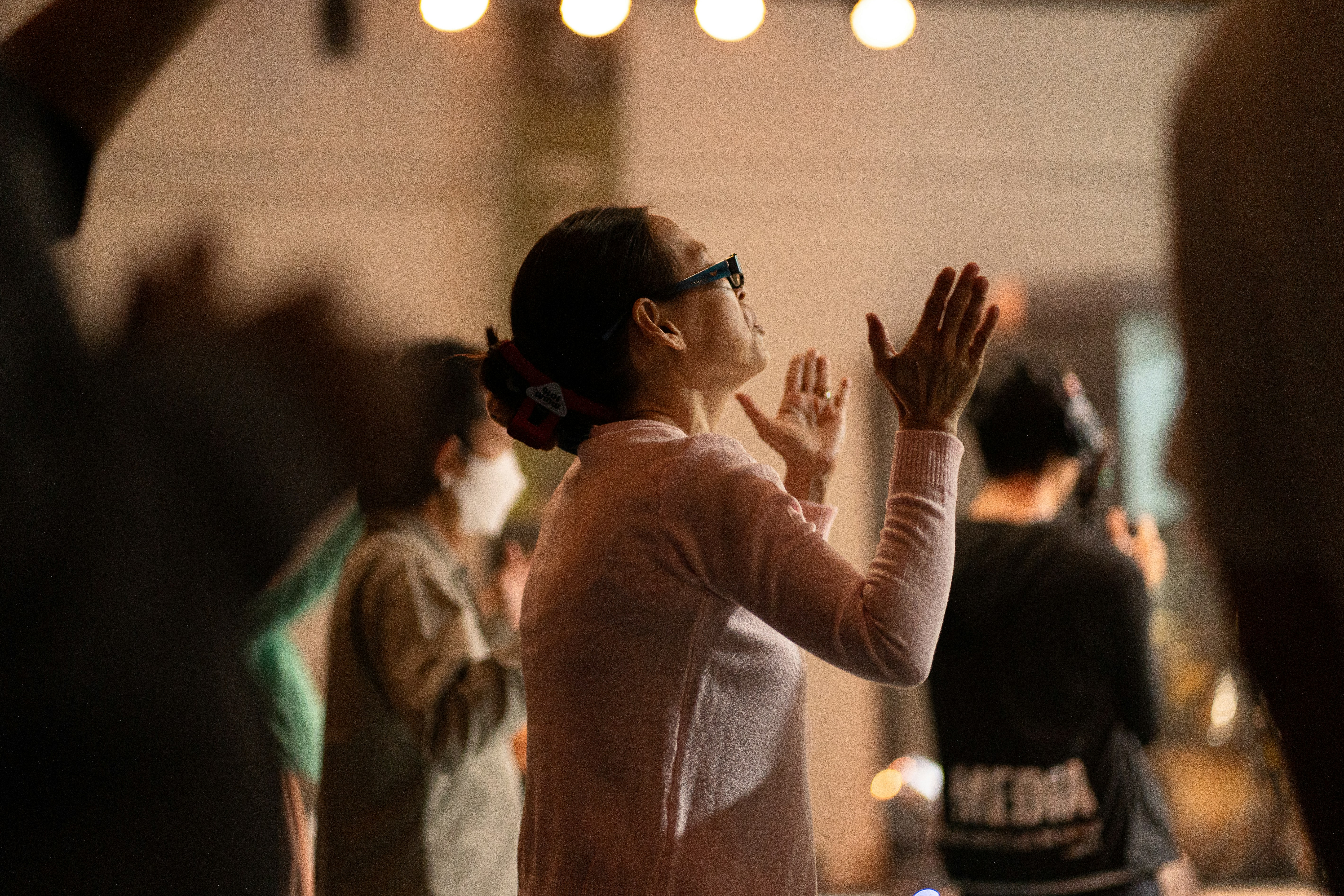 Center Stage: A Moment of Quiet Praise in a Crowd