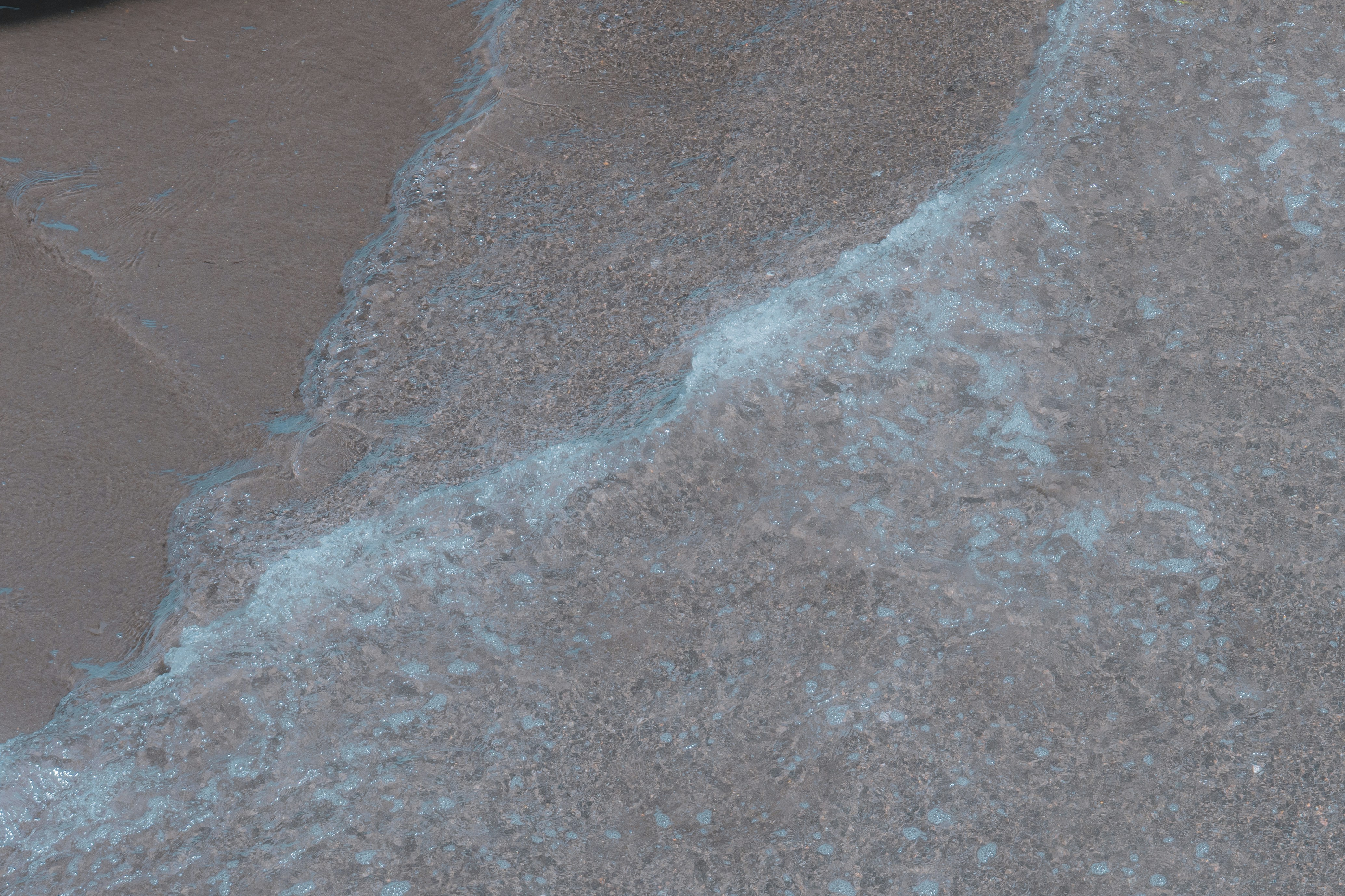Blue-tinged shoreline weave: abstract shoreline texture with frothy surf
