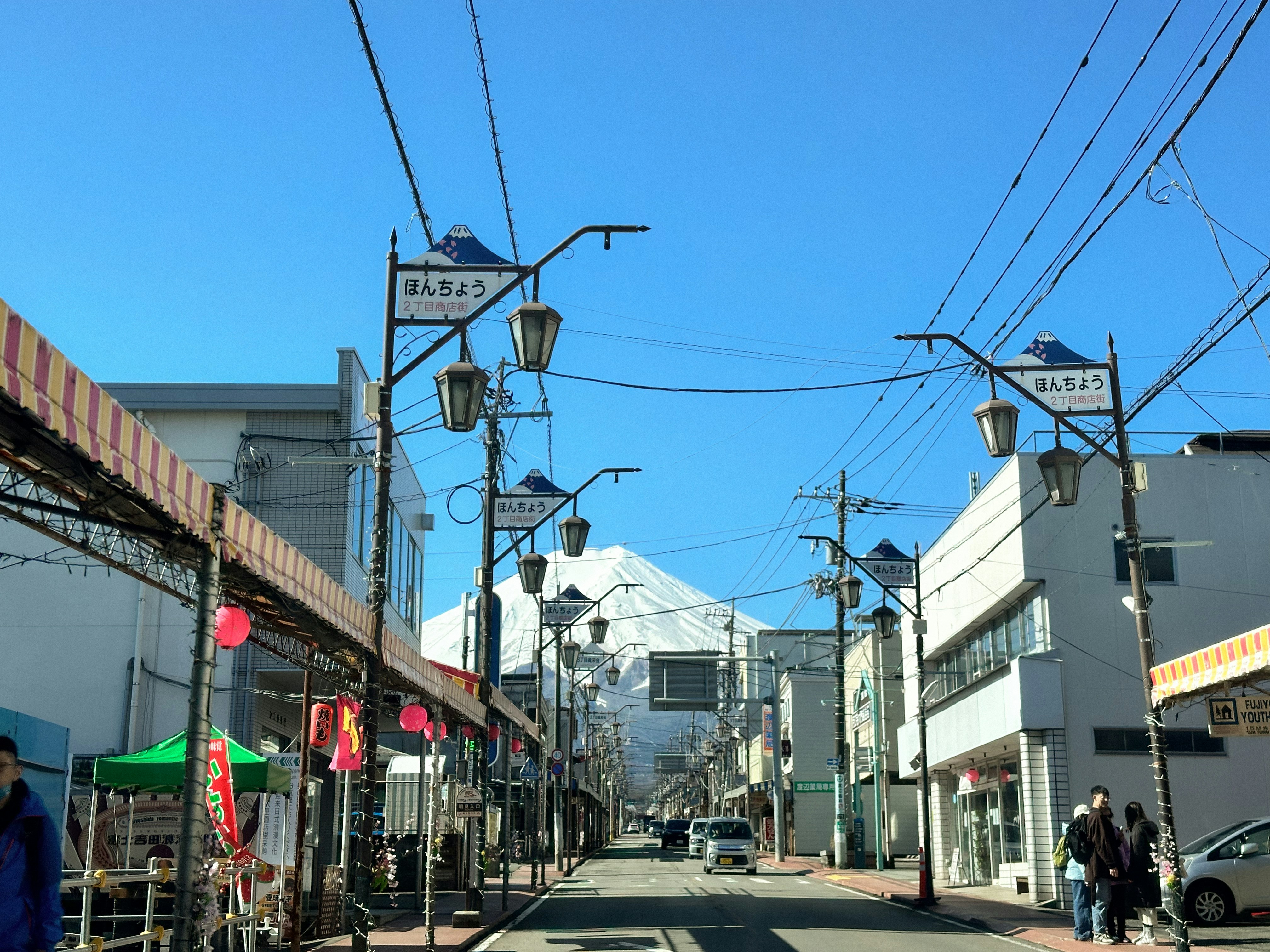 City Street Lanterns and Snow-Capped Peak View