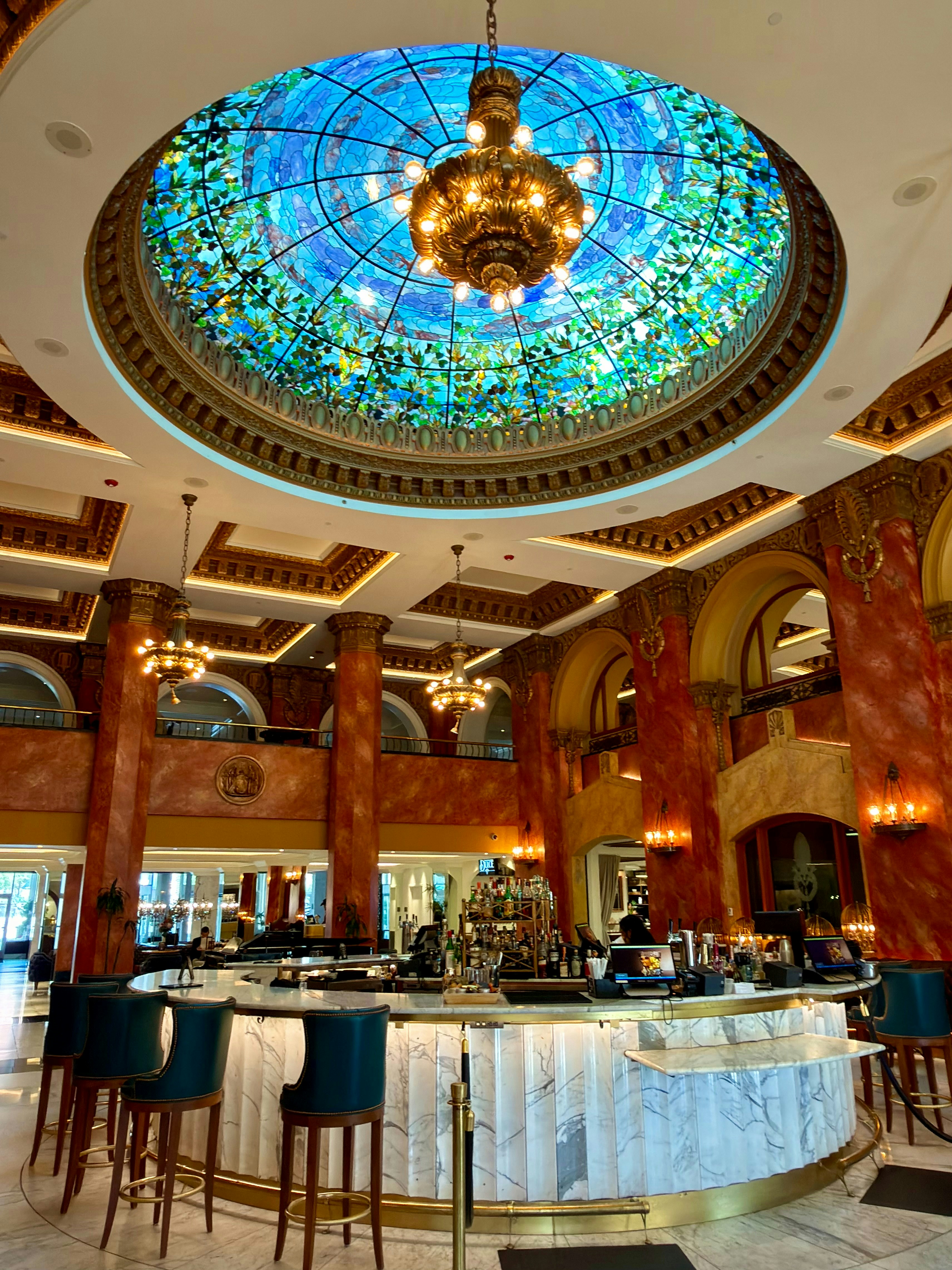 Ornate Hotel Bar Under a Stained Glass Dome