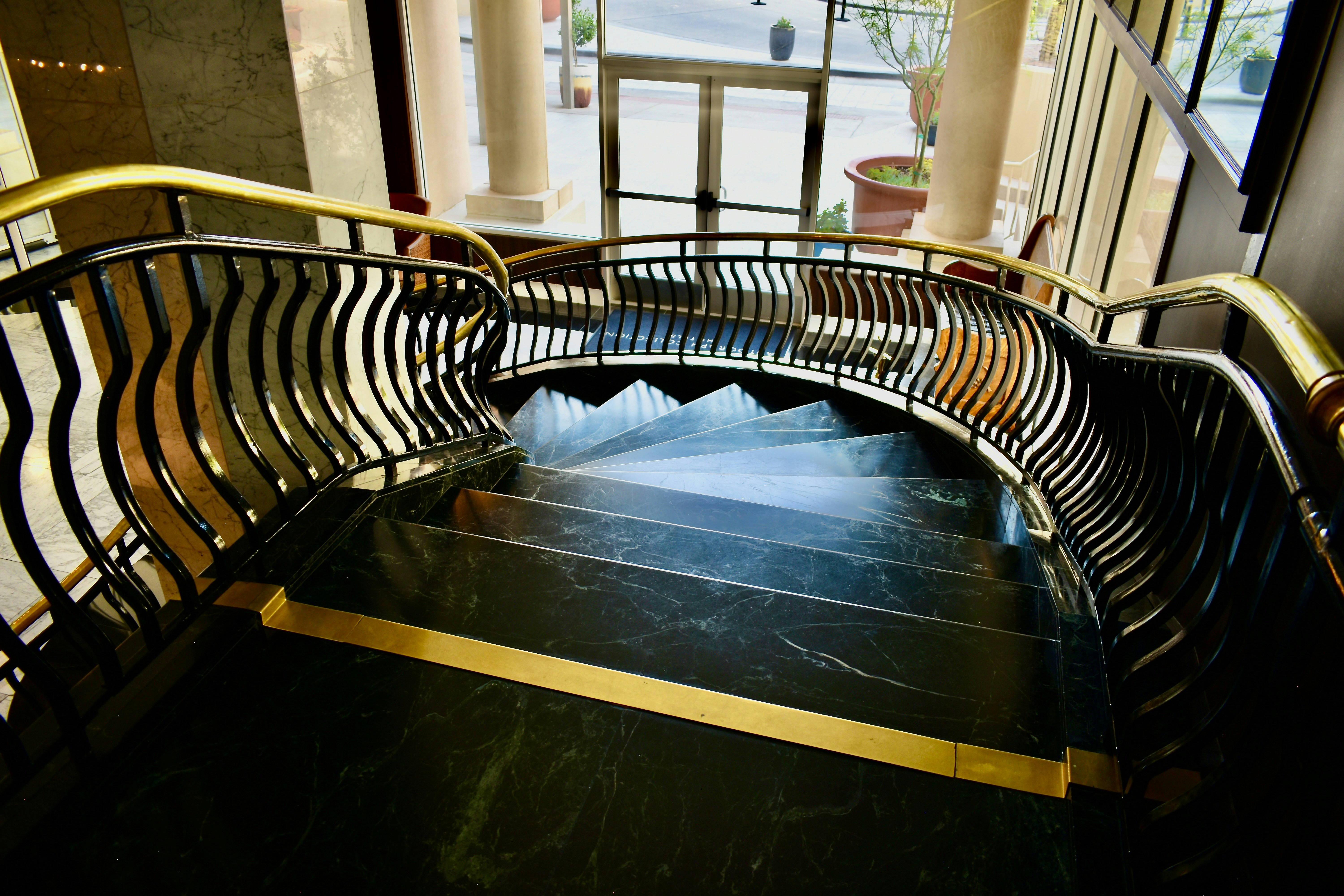 Symmetrical Staircase Framing Downward to an Illuminated Landing