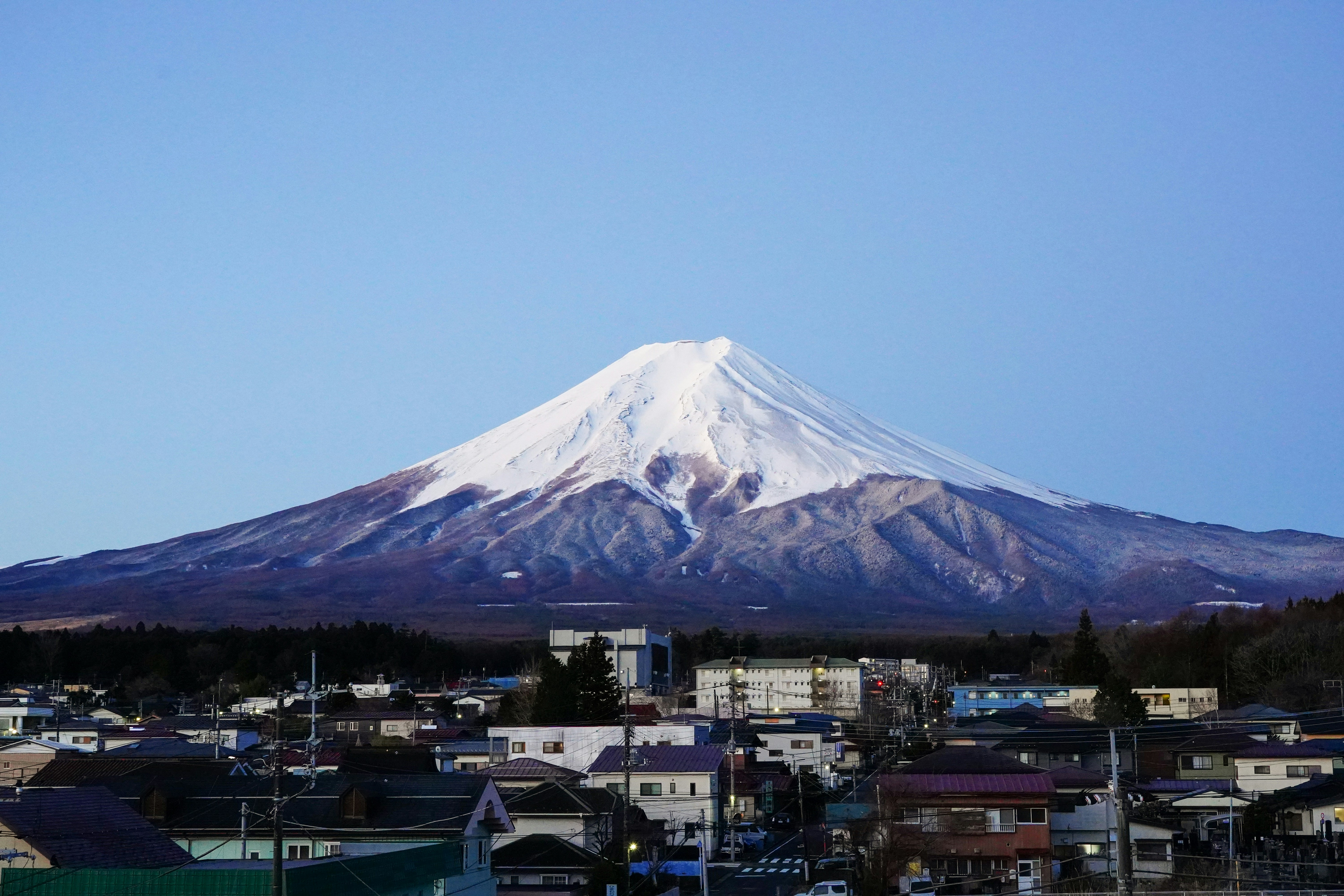 Snowy Peak over a Quiet Cityscape