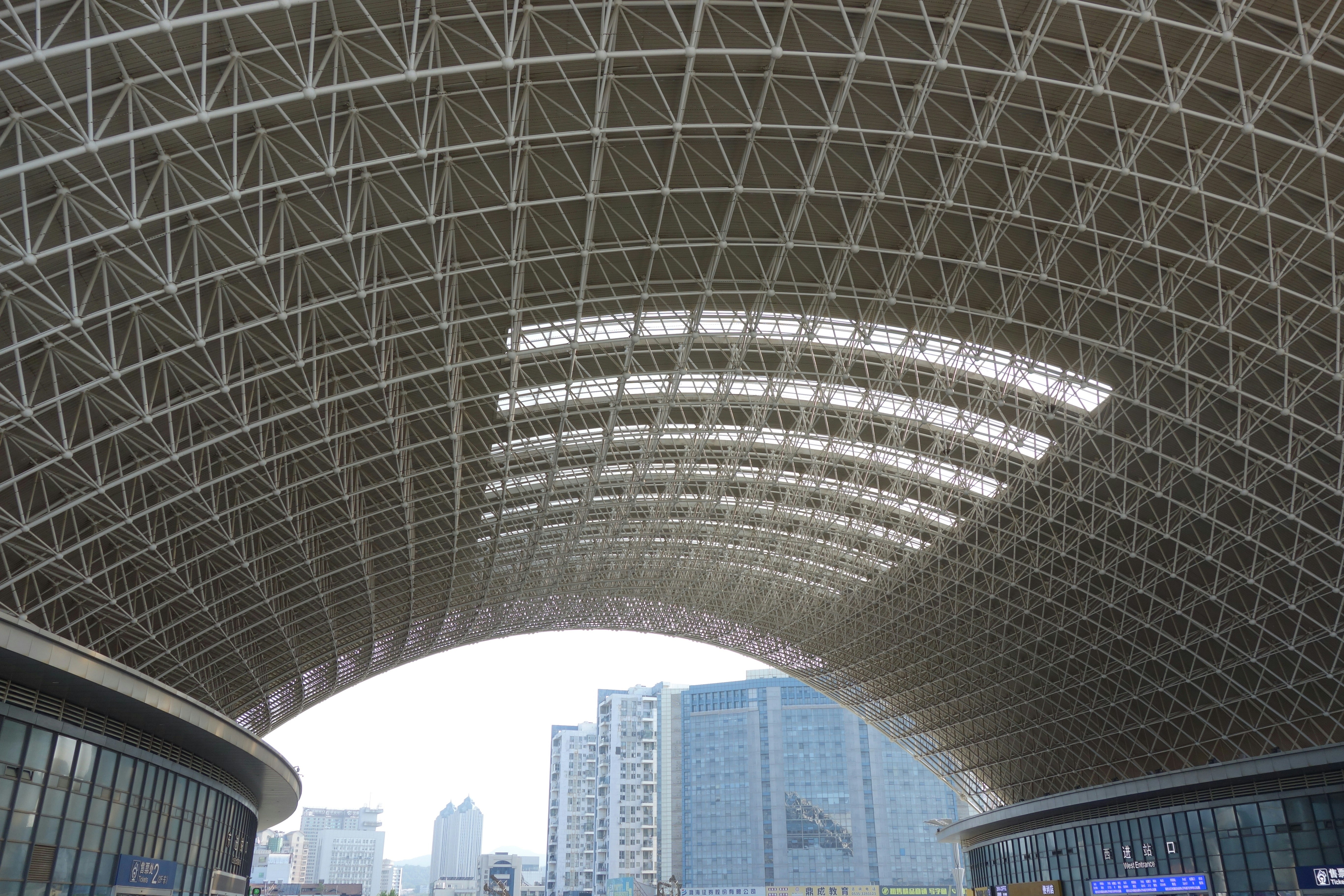 Archway of Sky and Steel: A City Courtyard Beneath a Lattice Dome