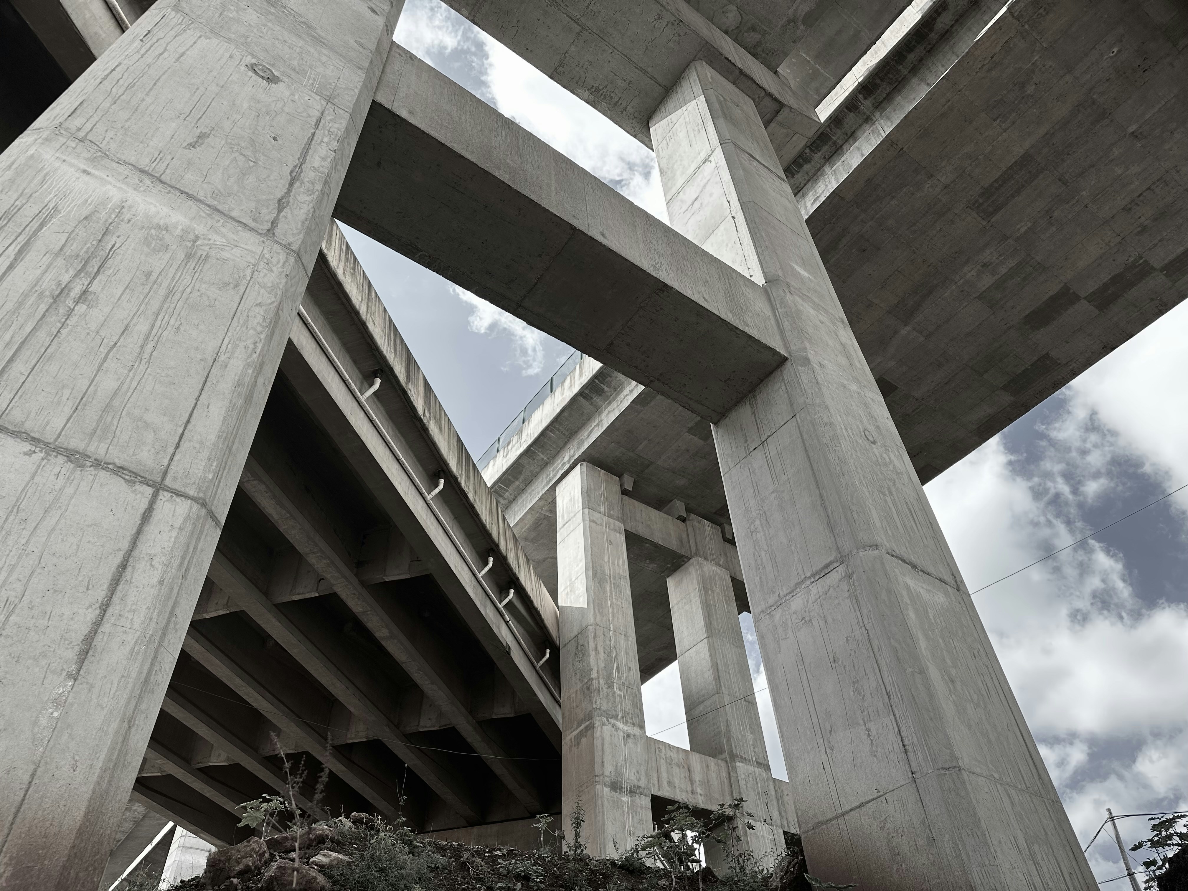 Monolithic Crossroads: Concrete Beams Thread the Sky