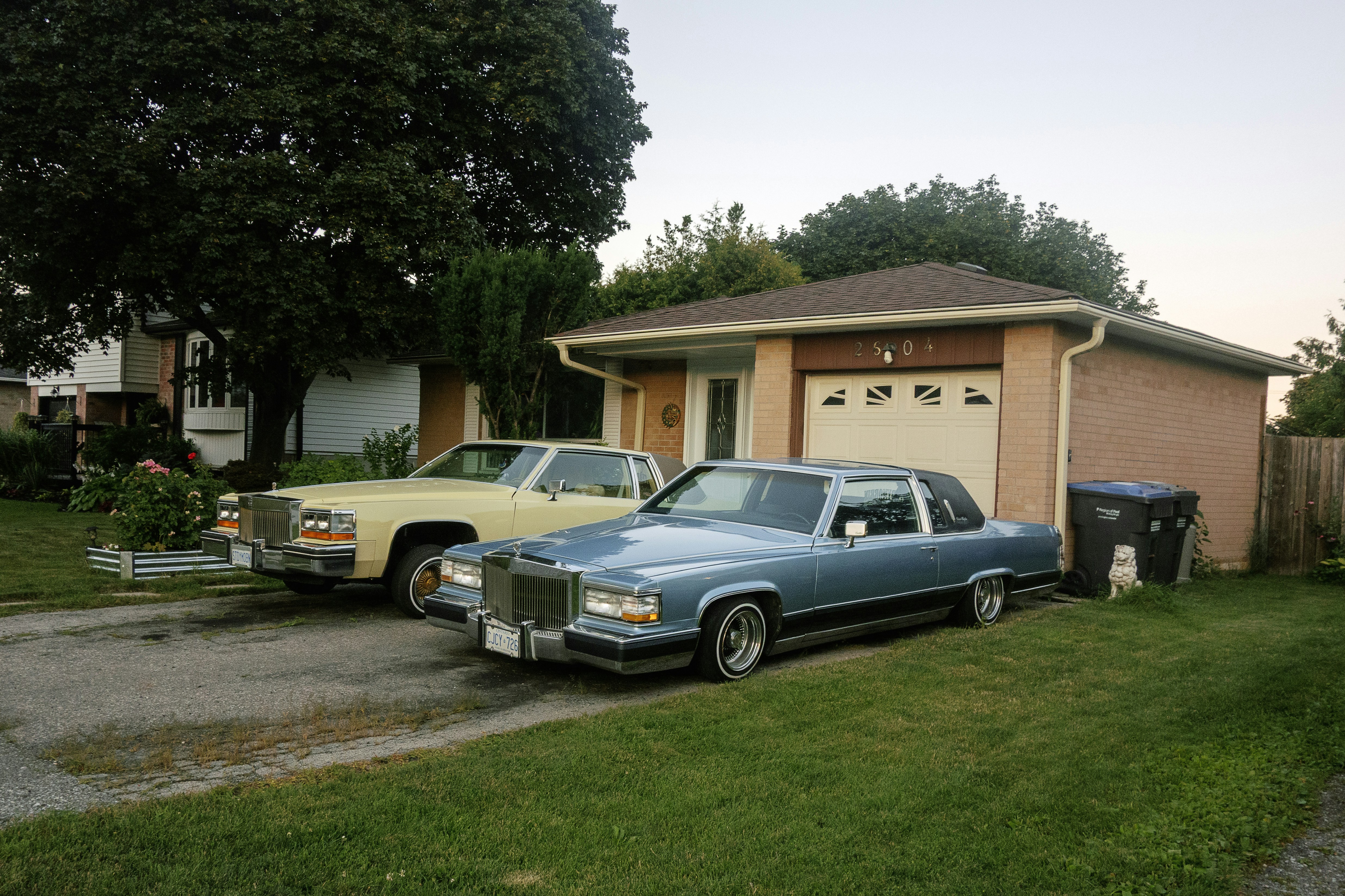 Blue Classic: A Pair of Vintage Cars Gracing a Suburban Drive