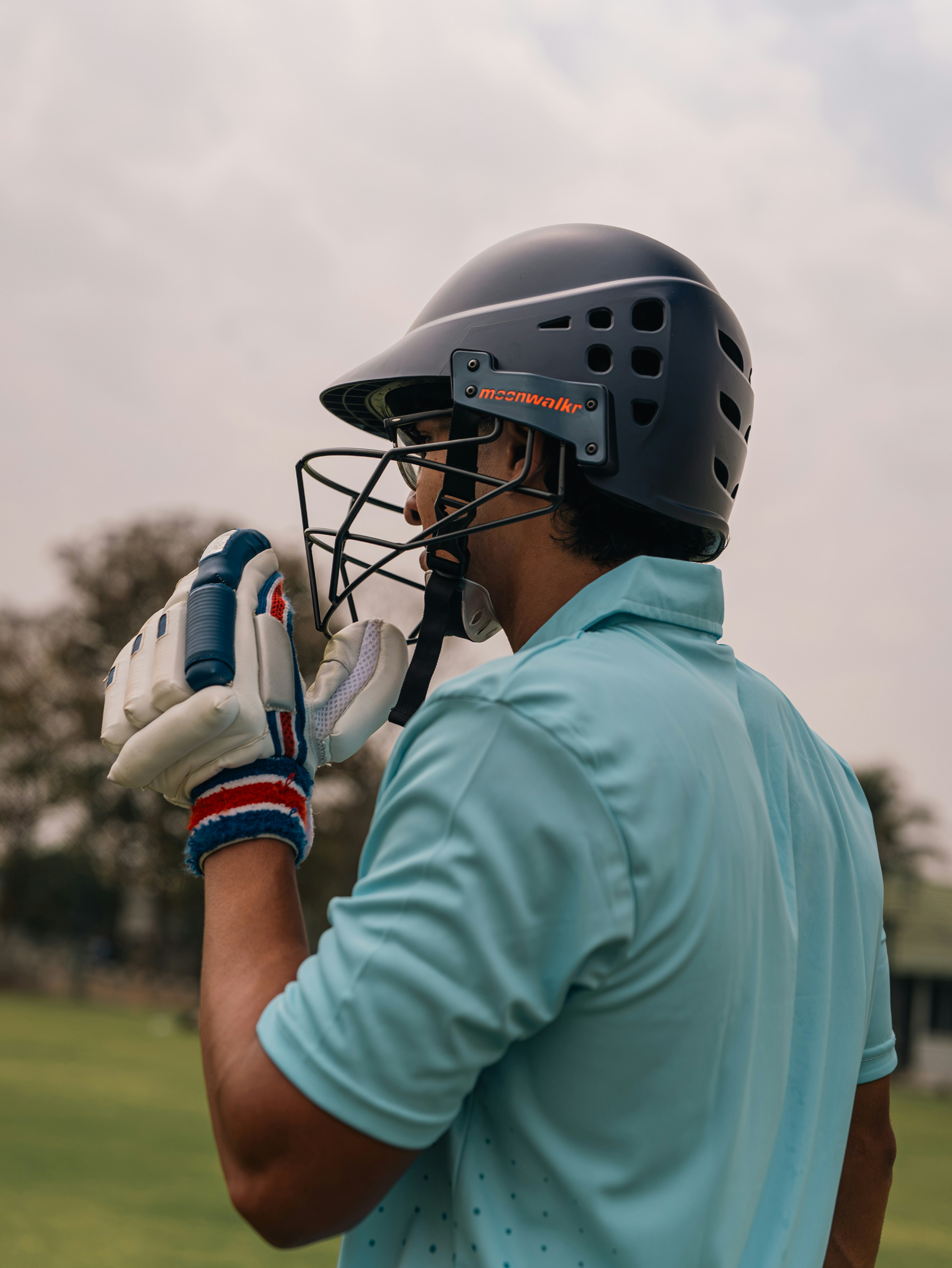 Helmeted batter preparing for the pitch: close-up of a cradled stance