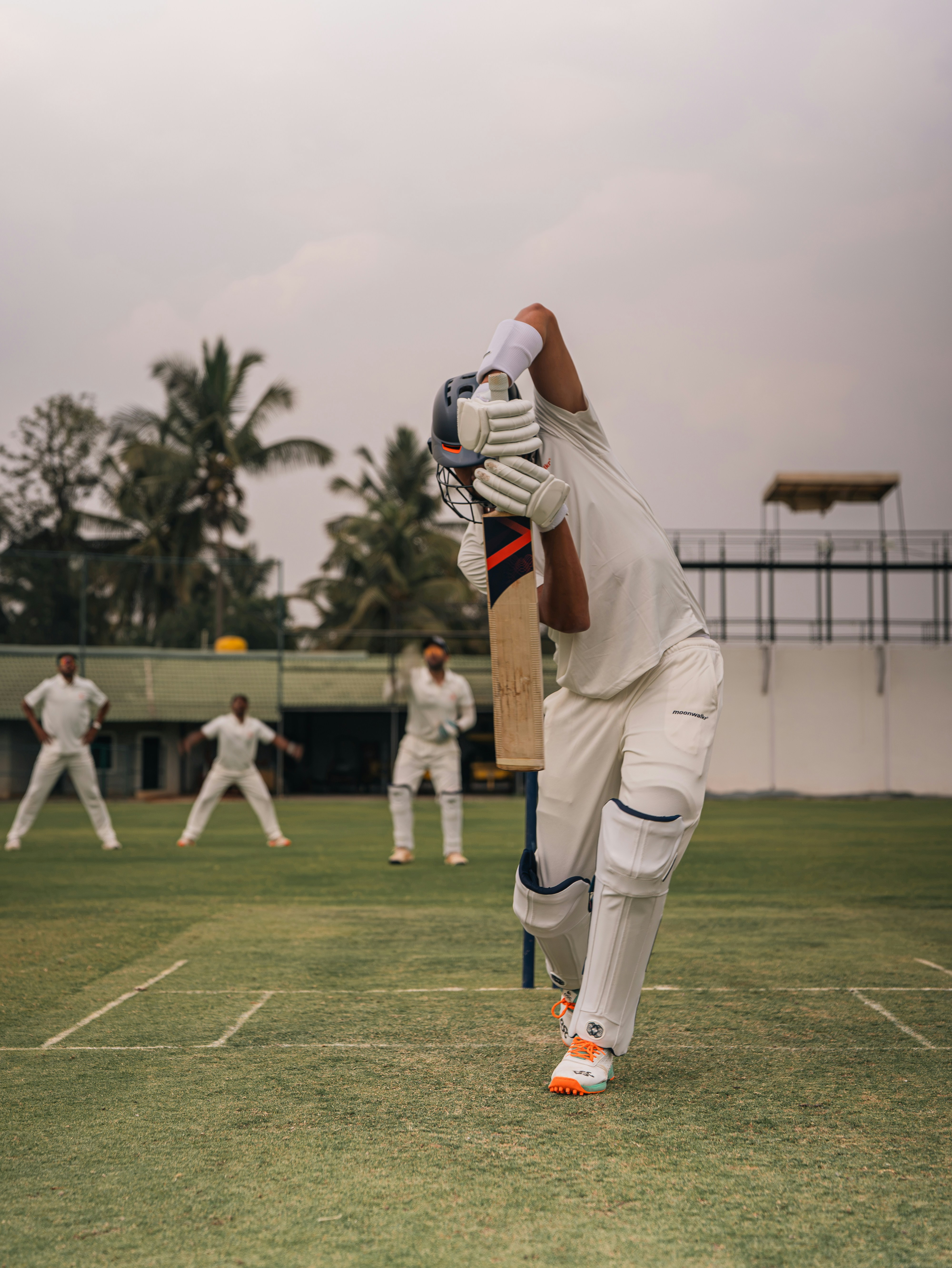 Cricket Batsman in Focus: Follow-through Under the Evening Sky