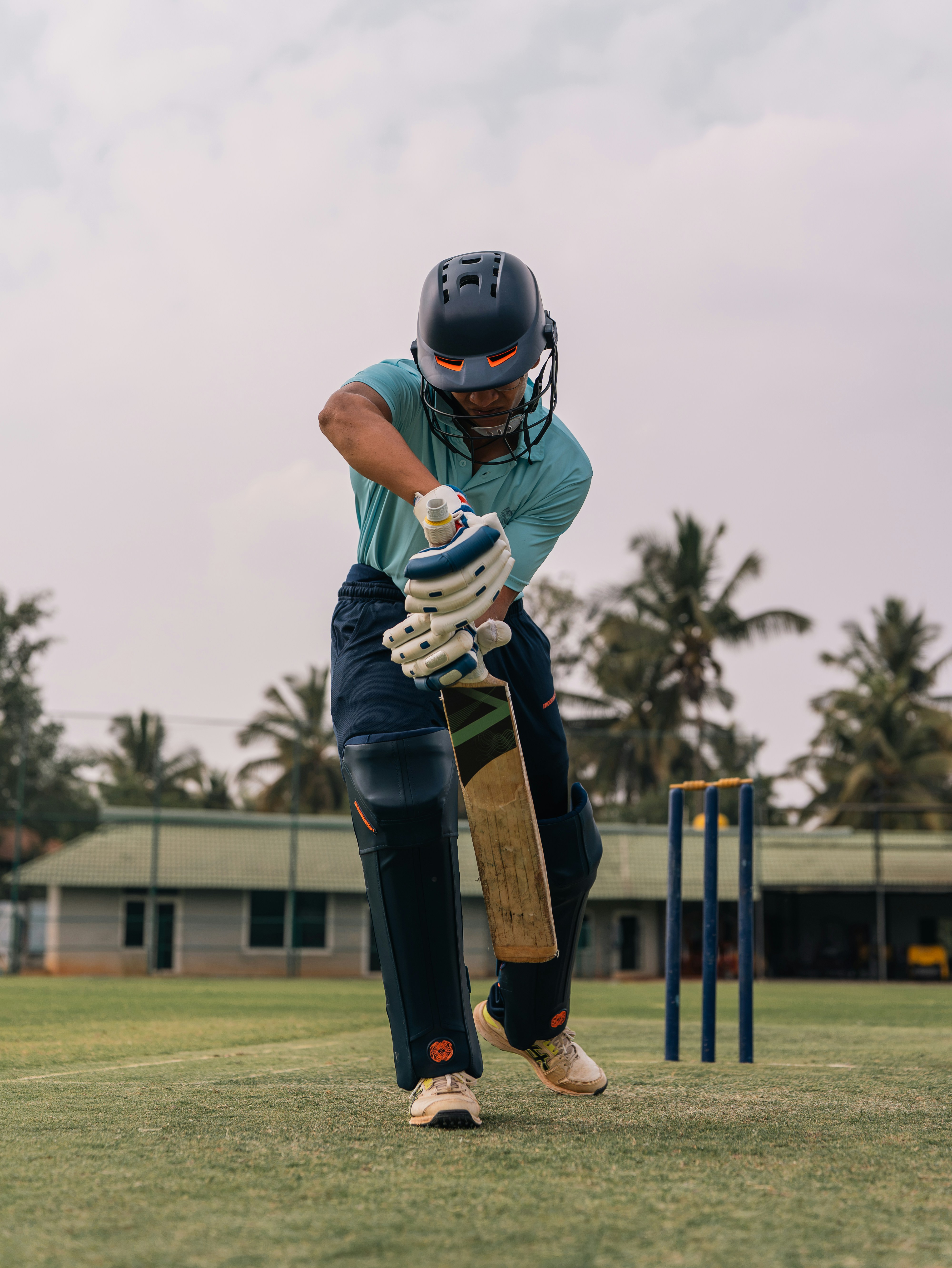 Cricketer in Full Swing: The Bat Finds Its Mark on a Sunny Field