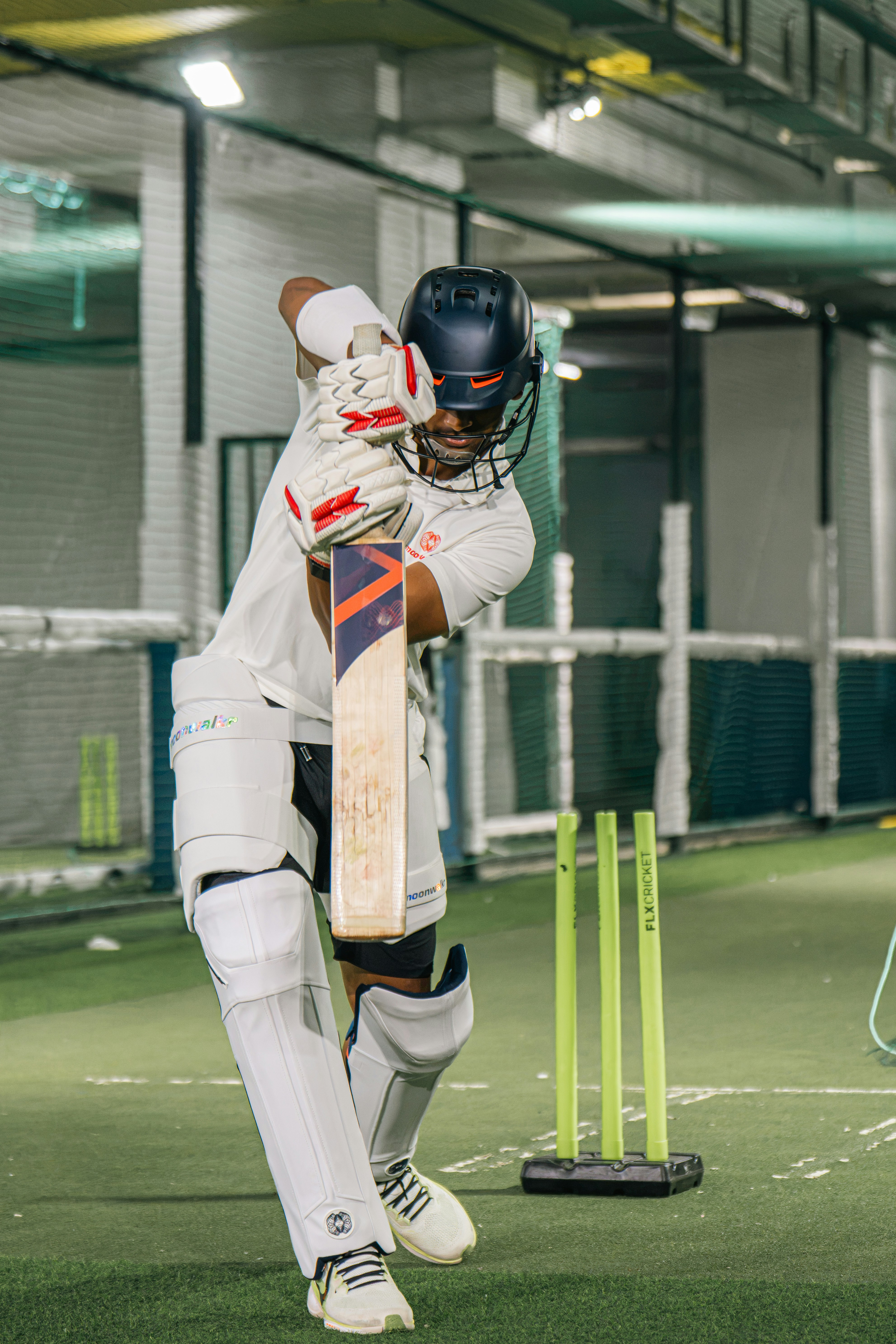 Cricket bat in focus: batter locked in at the crease