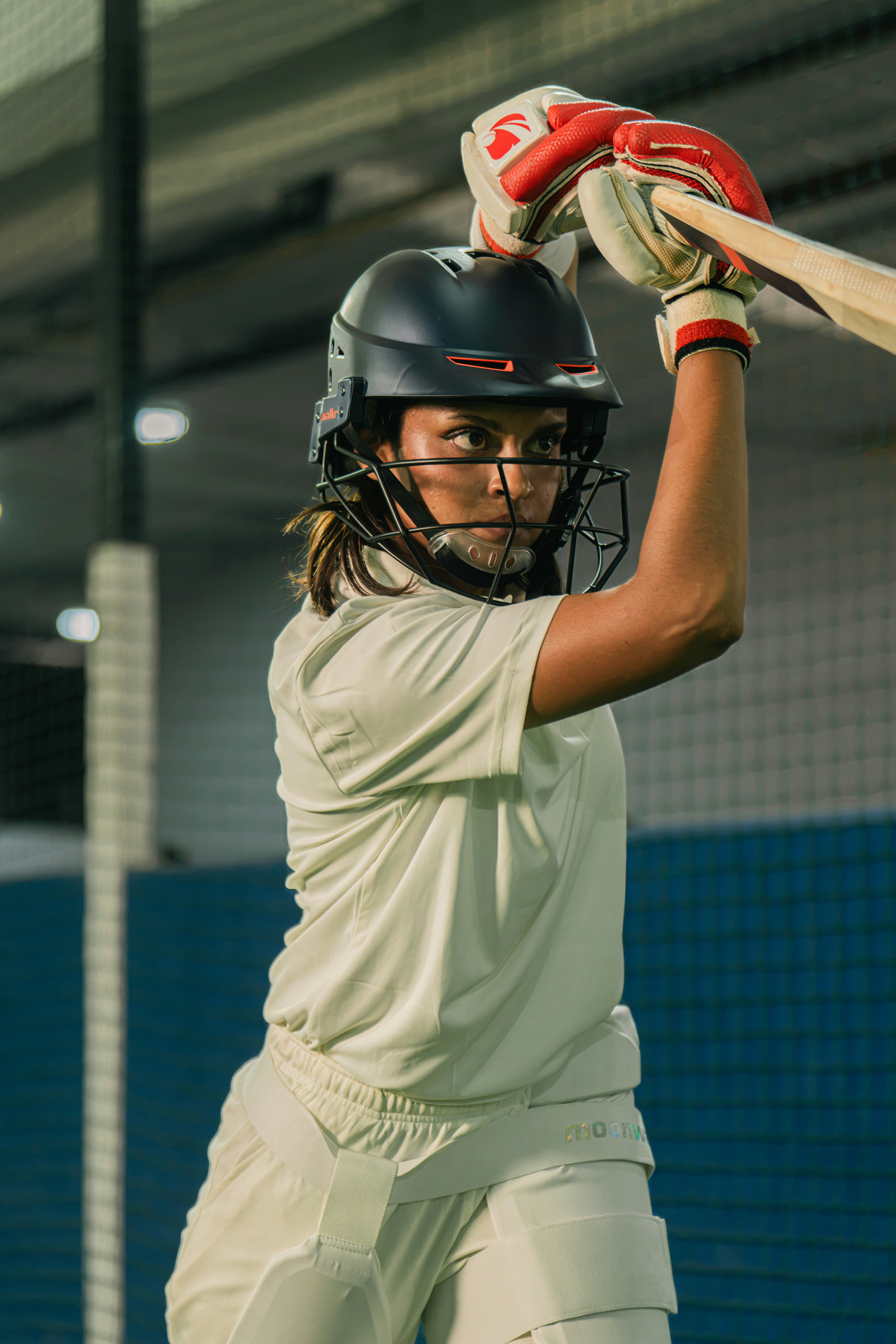 Swinging for the Win: A Batter's Focused Moment in Indoor Cricket