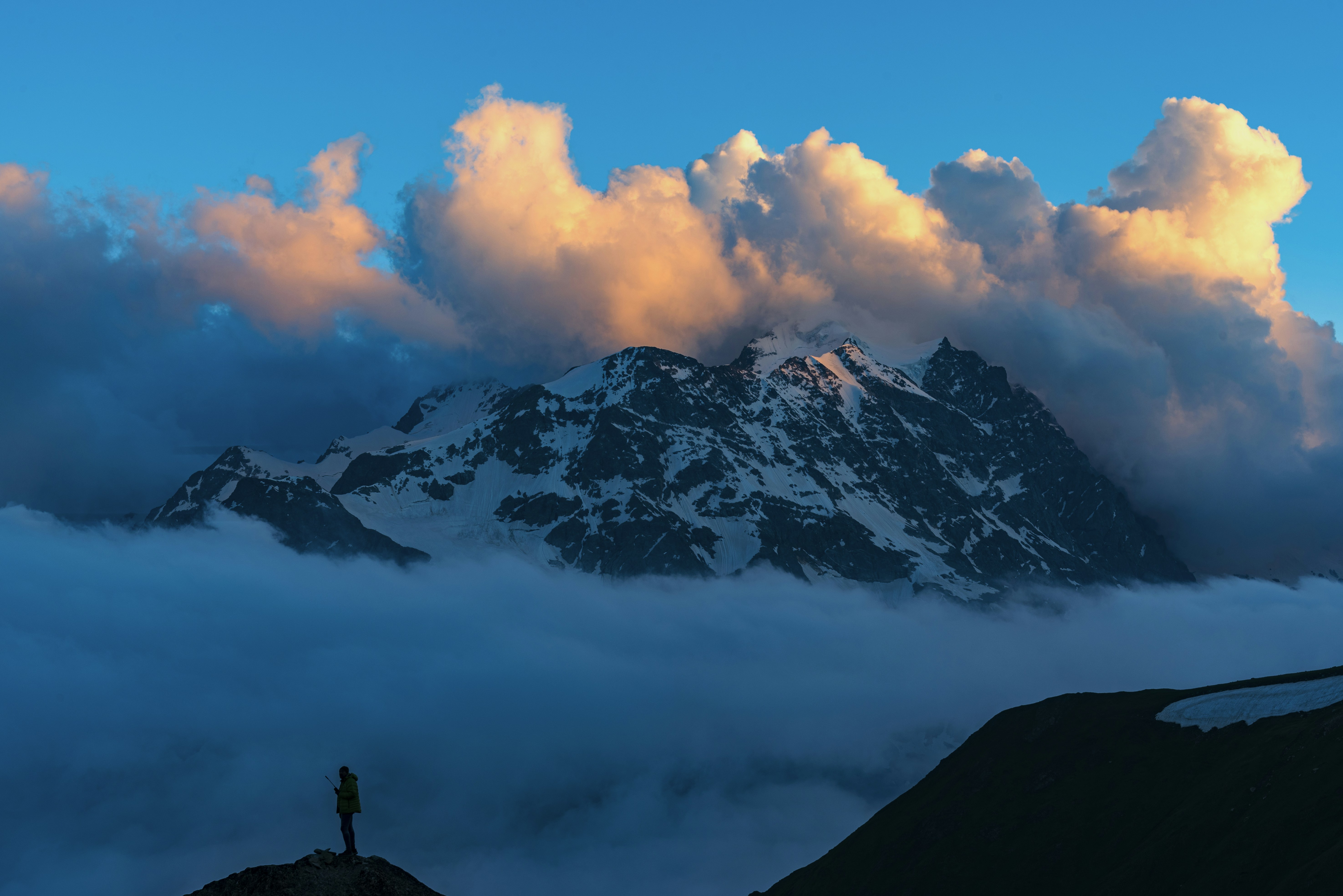 Glacial Peak Beneath Ember Clouds