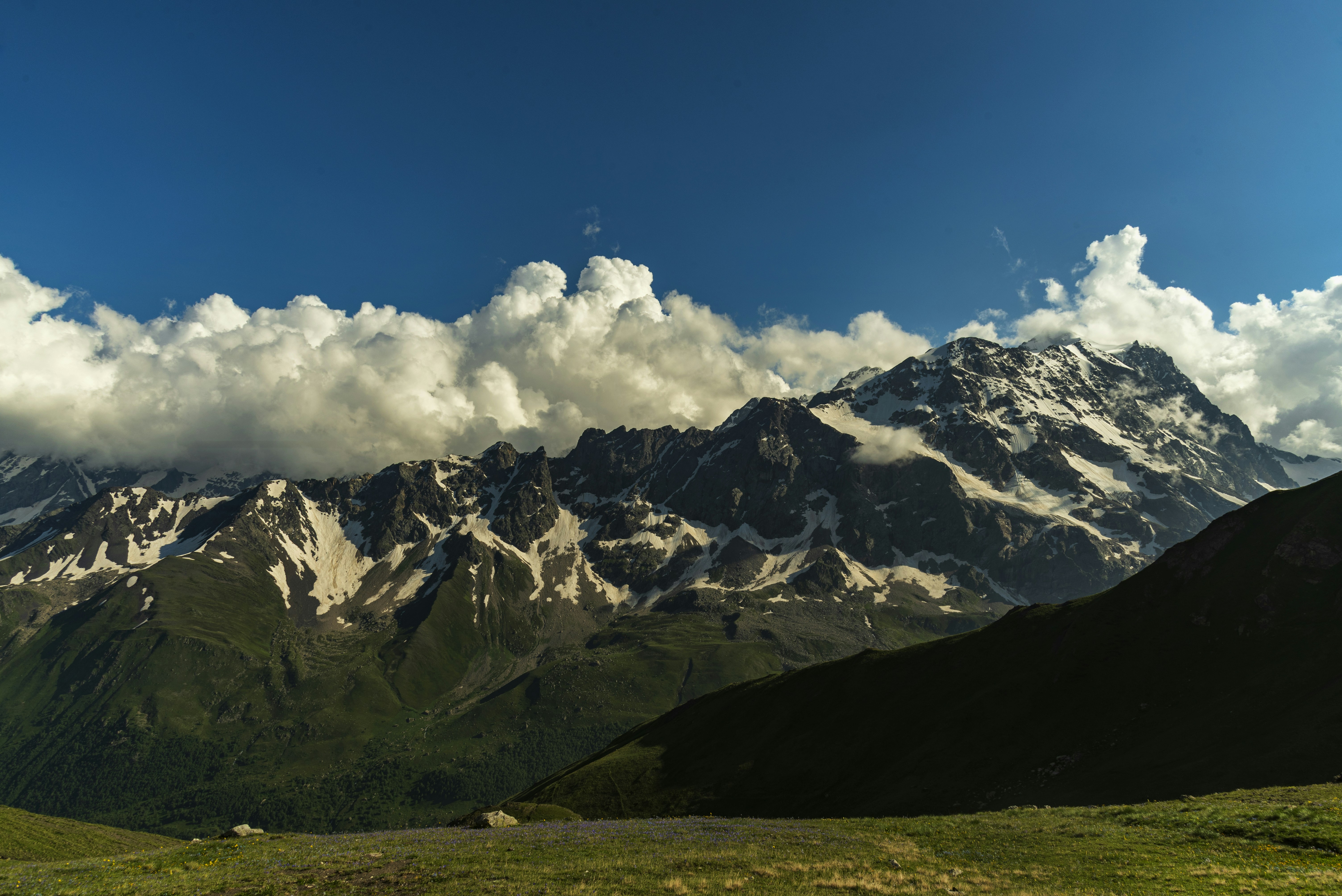 Snow-kissed Peaks under a Dramatic Sky