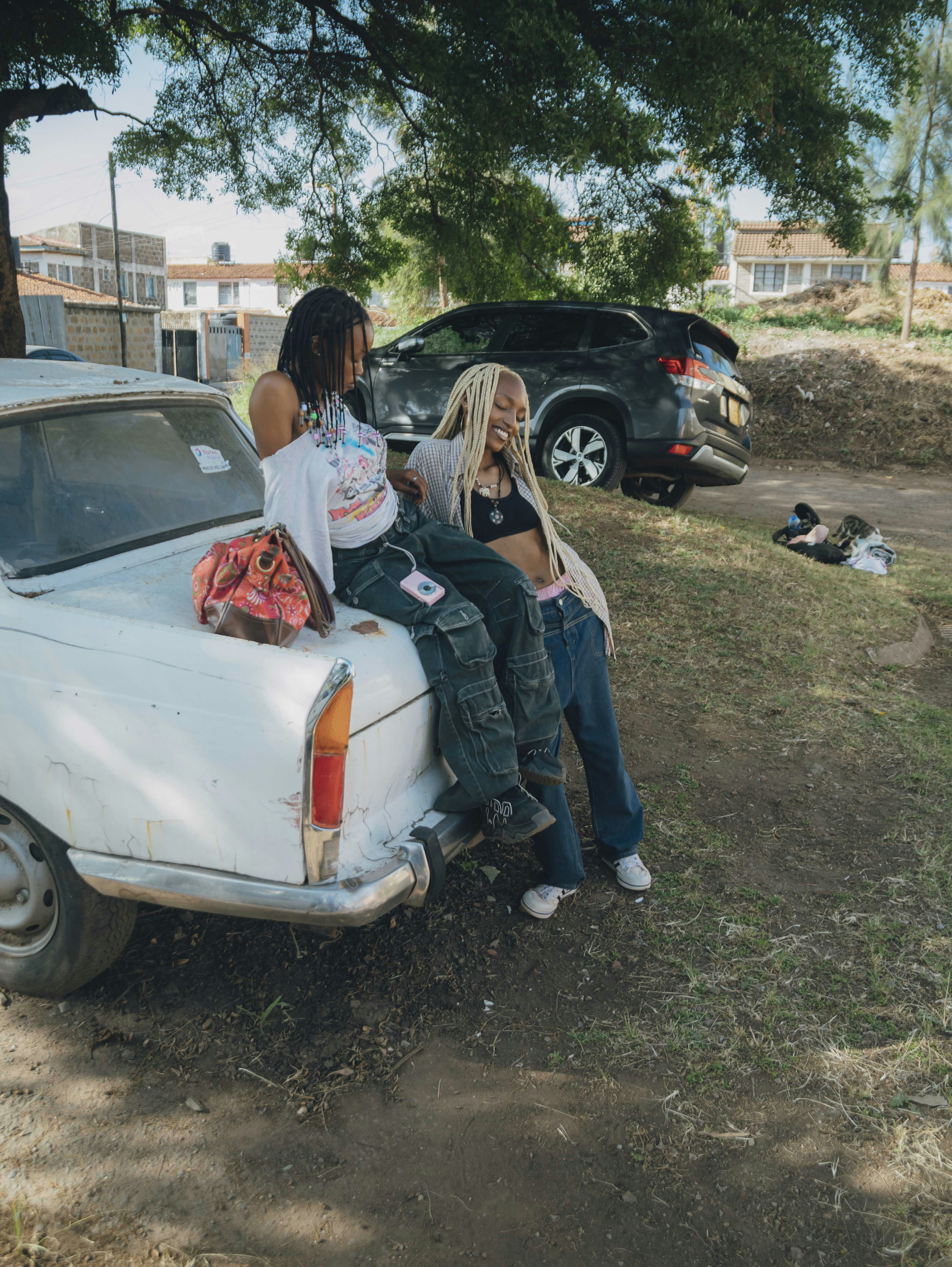 Friends on an Old Sedan: Sunset Sparks and Lively Chats