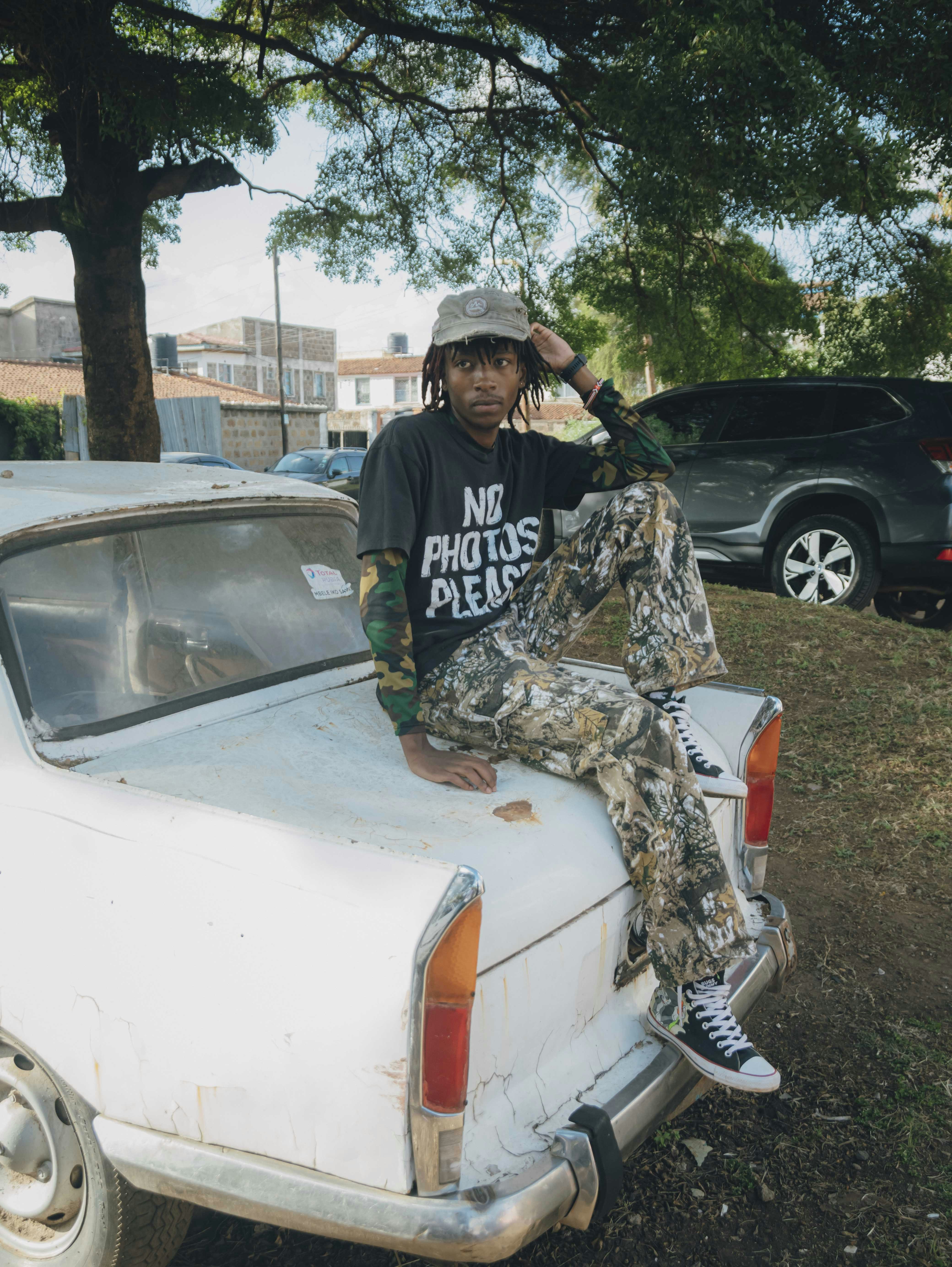 Sitting on the Rails: Portrait atop an Aged Car