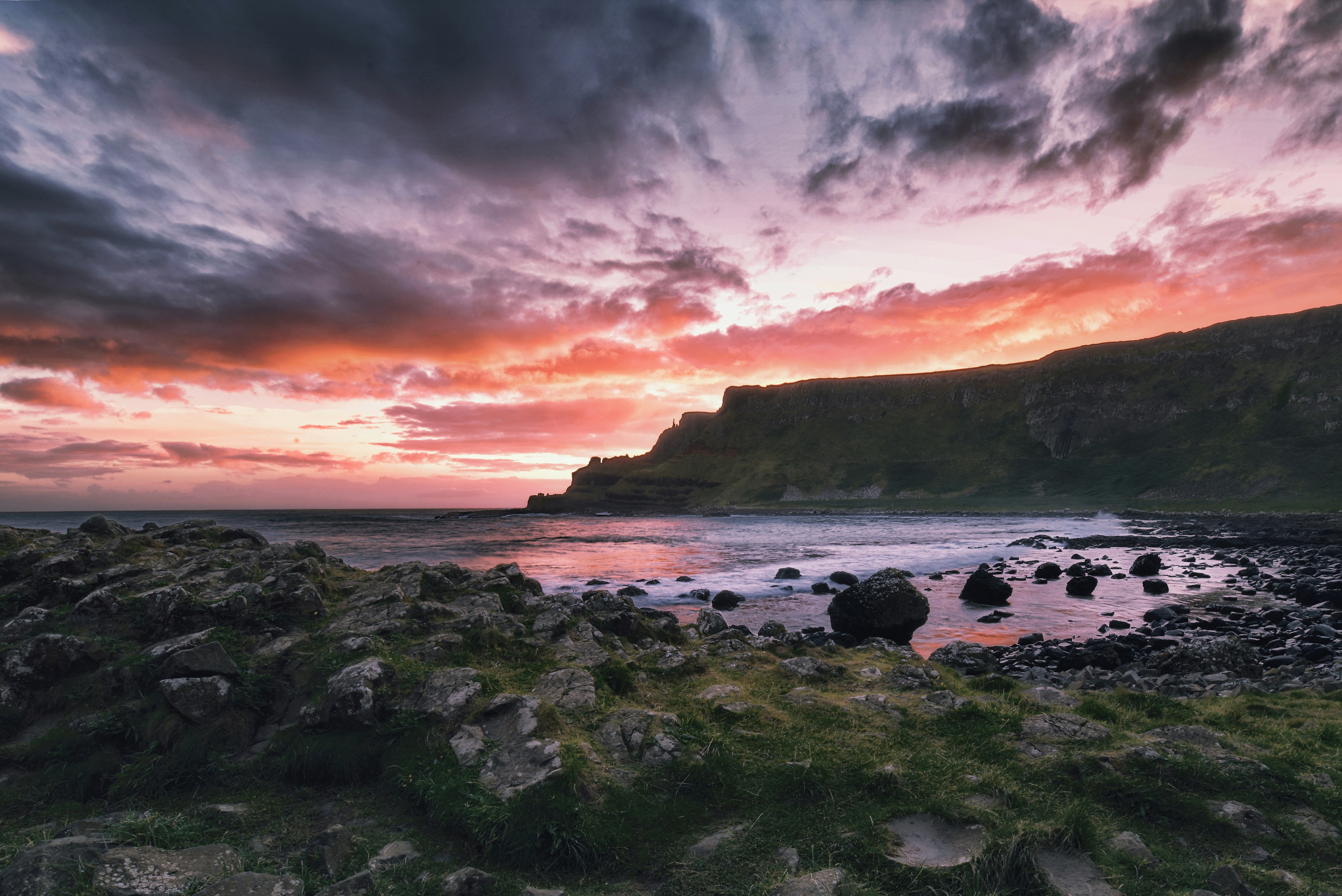 Sunset Over Rugged Shoreline with Mossy Rocks