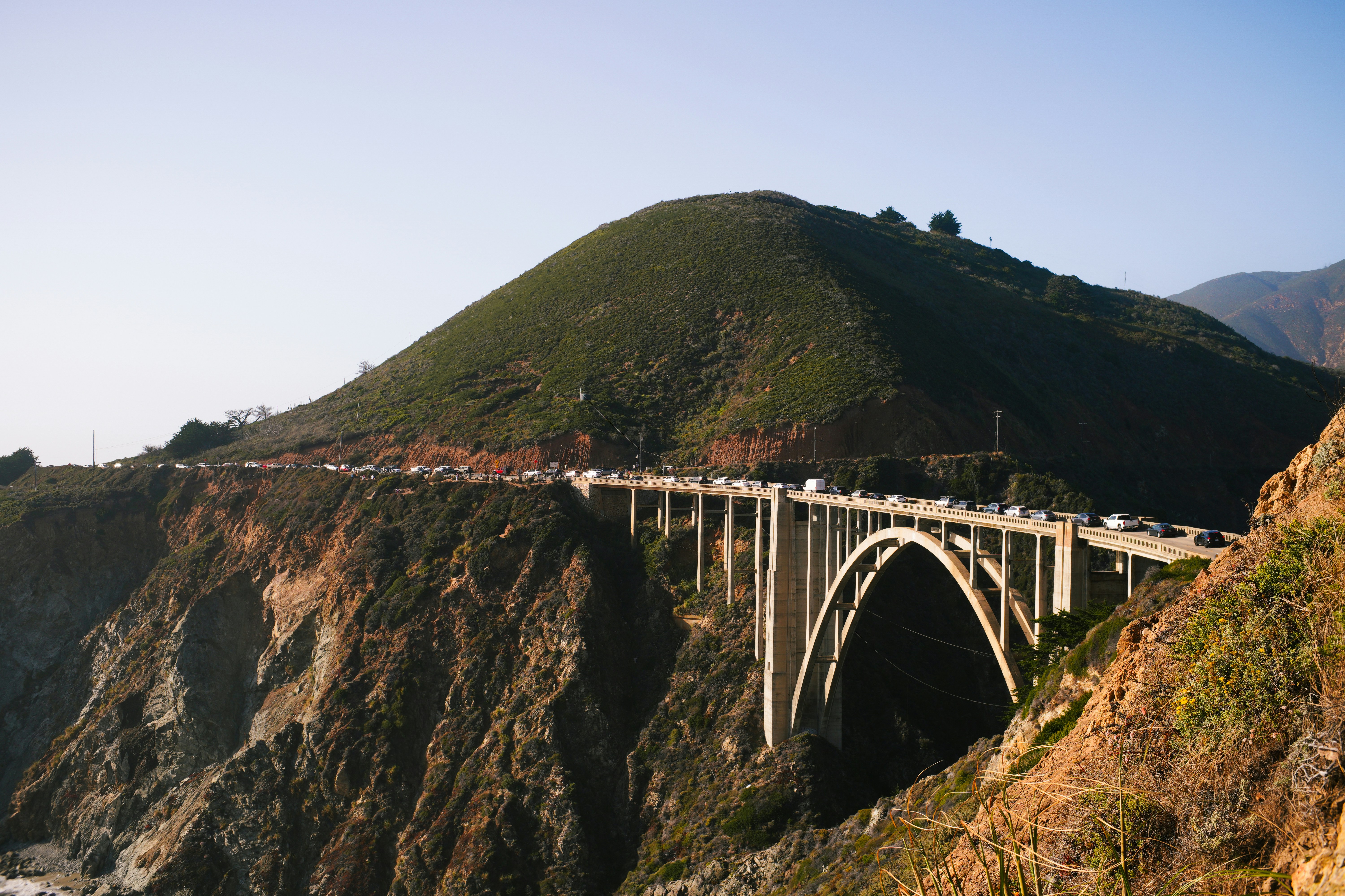 Suspended Over the Coast: A Crescent of Rocks and a Silent Bridge