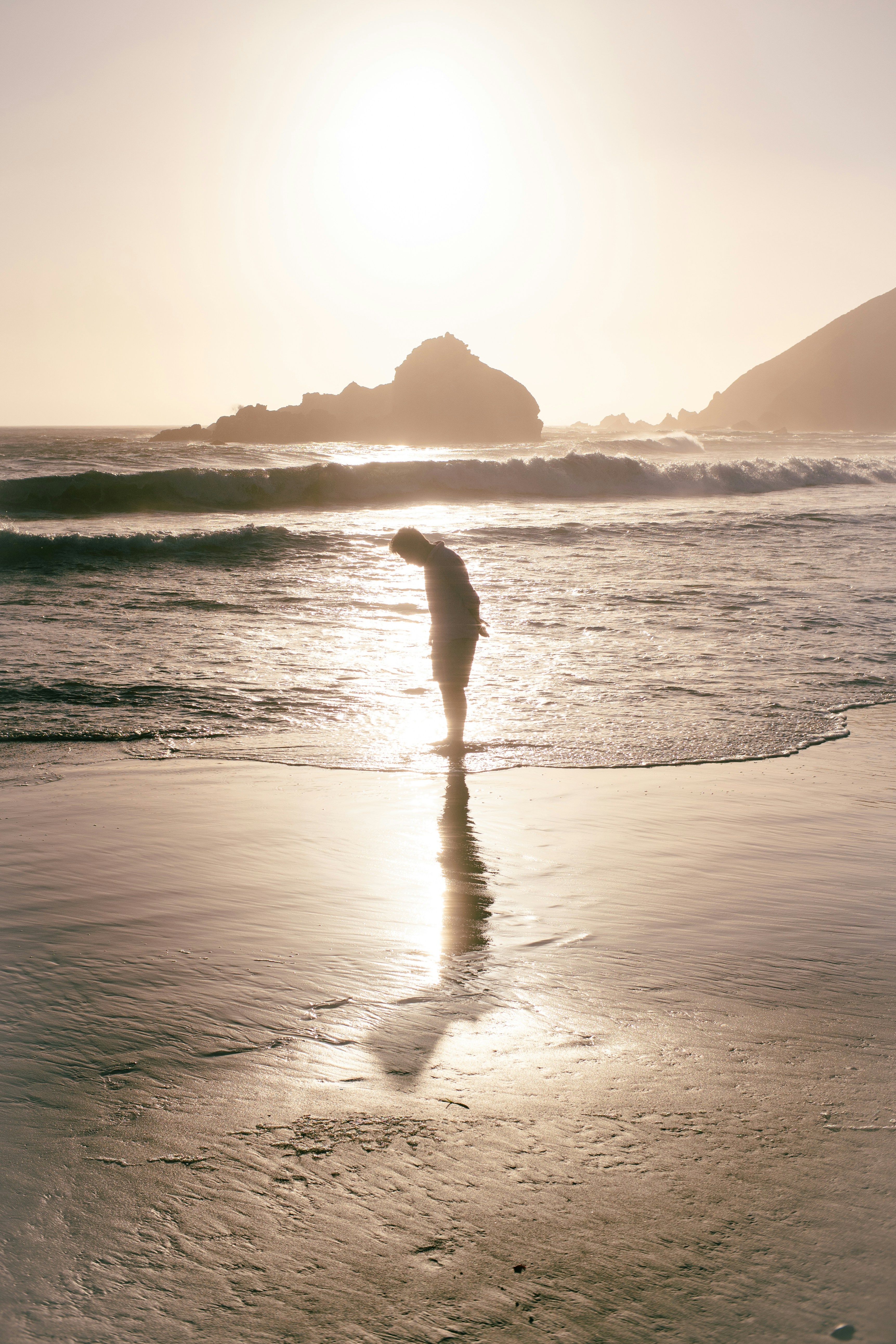 Silhouette at Sundown: A Lone Figure on Quiet Tides