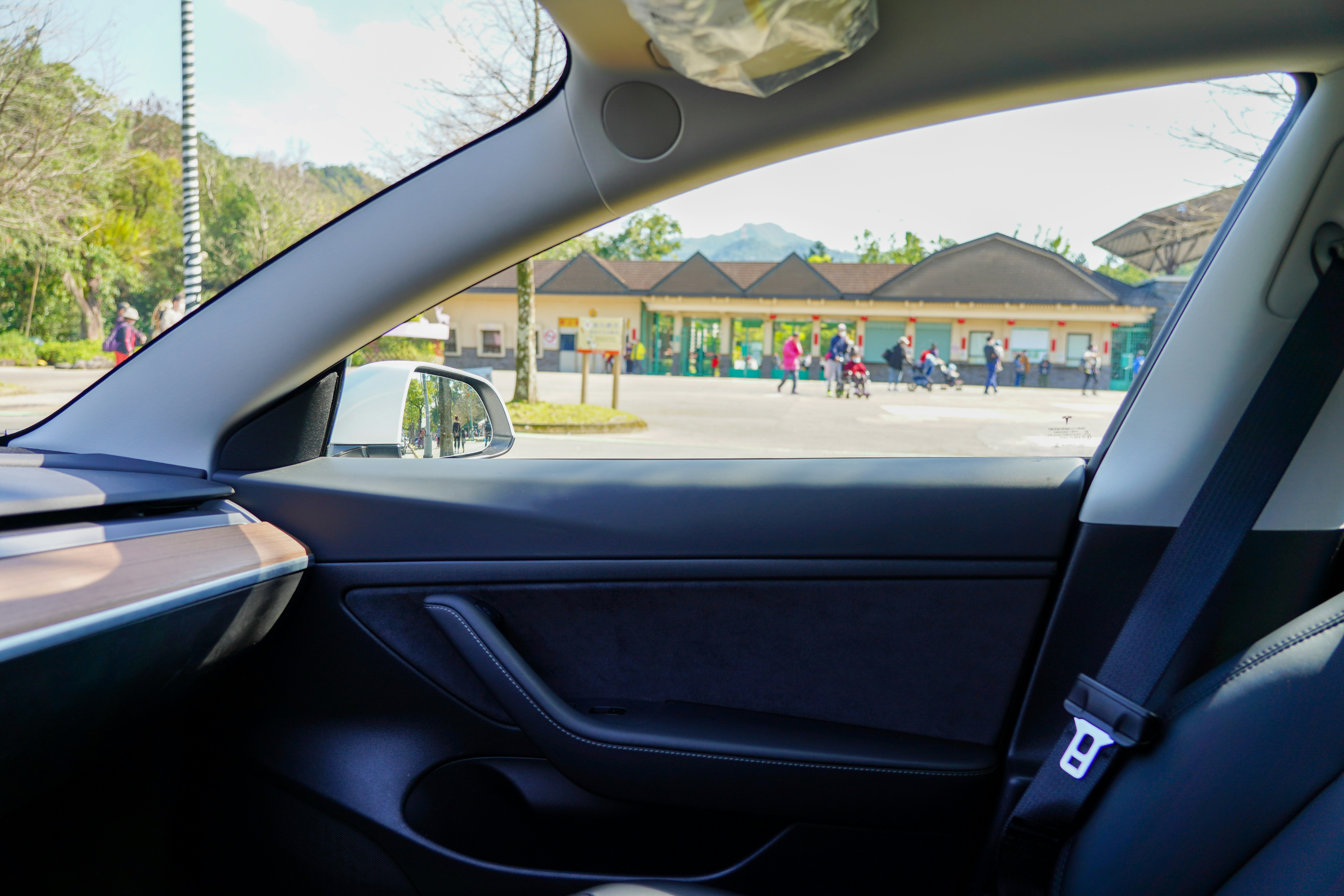 Window View from the Car: School Courtyard Framing the Drive