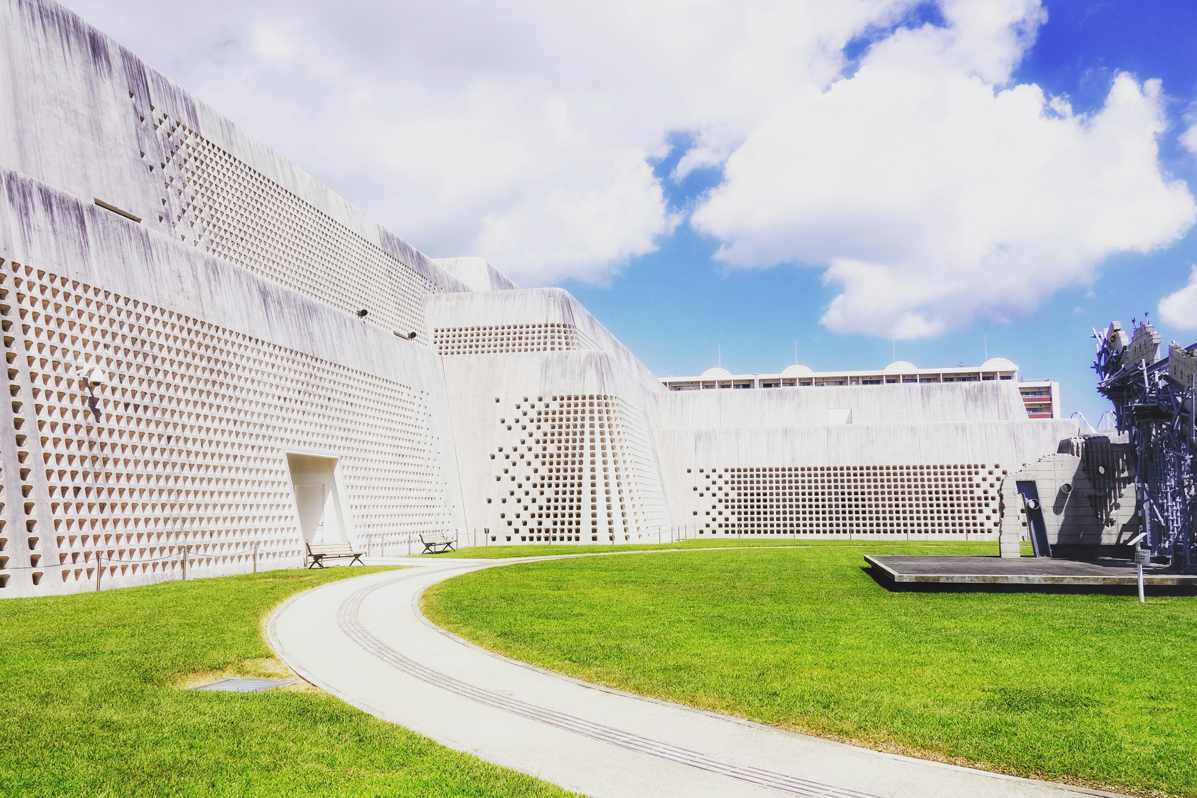 Curved Path Through a Sunlit Concrete Courtyard