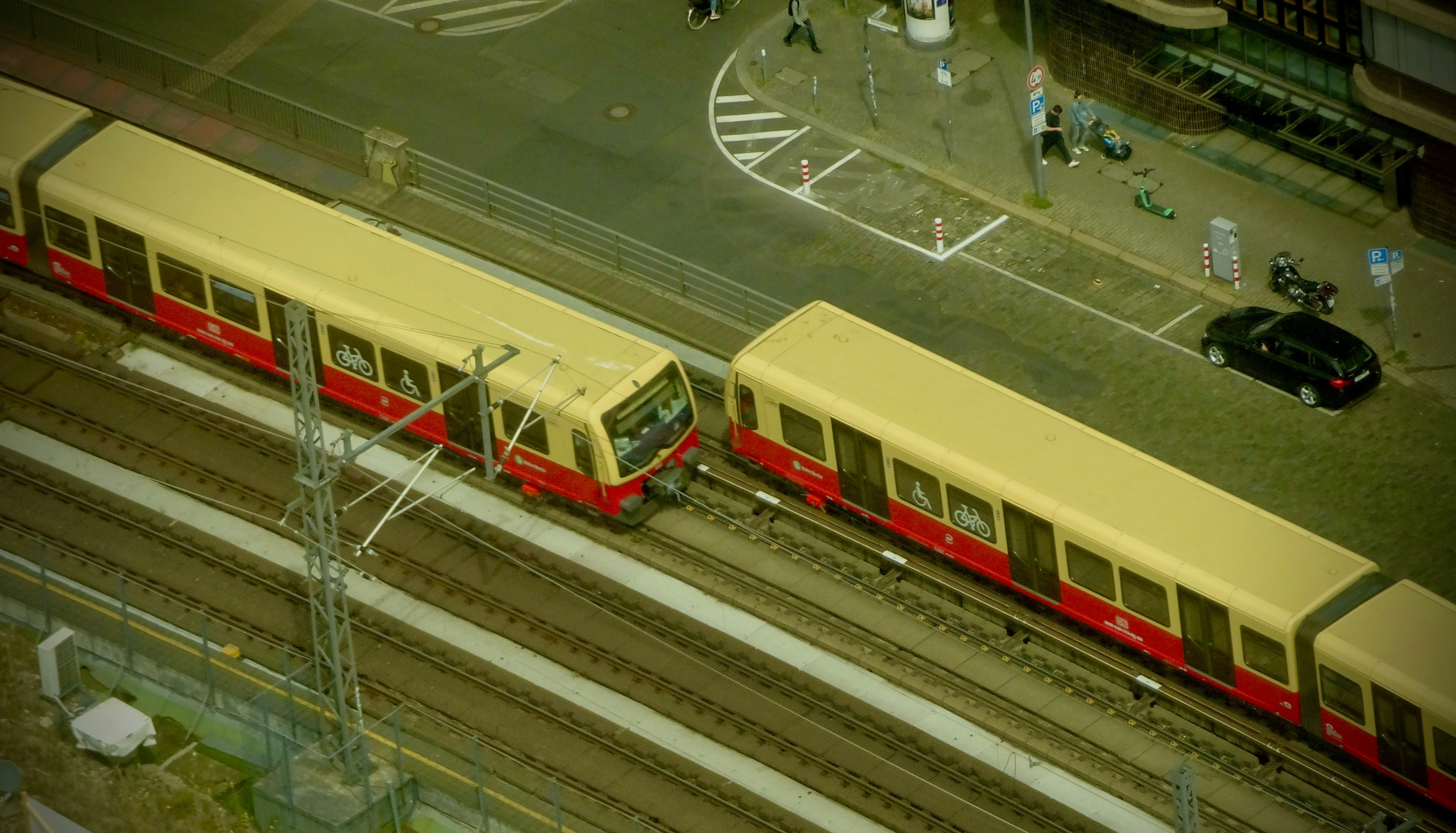 Overhead Rail Car Duo: Aerial View of a Station Run
