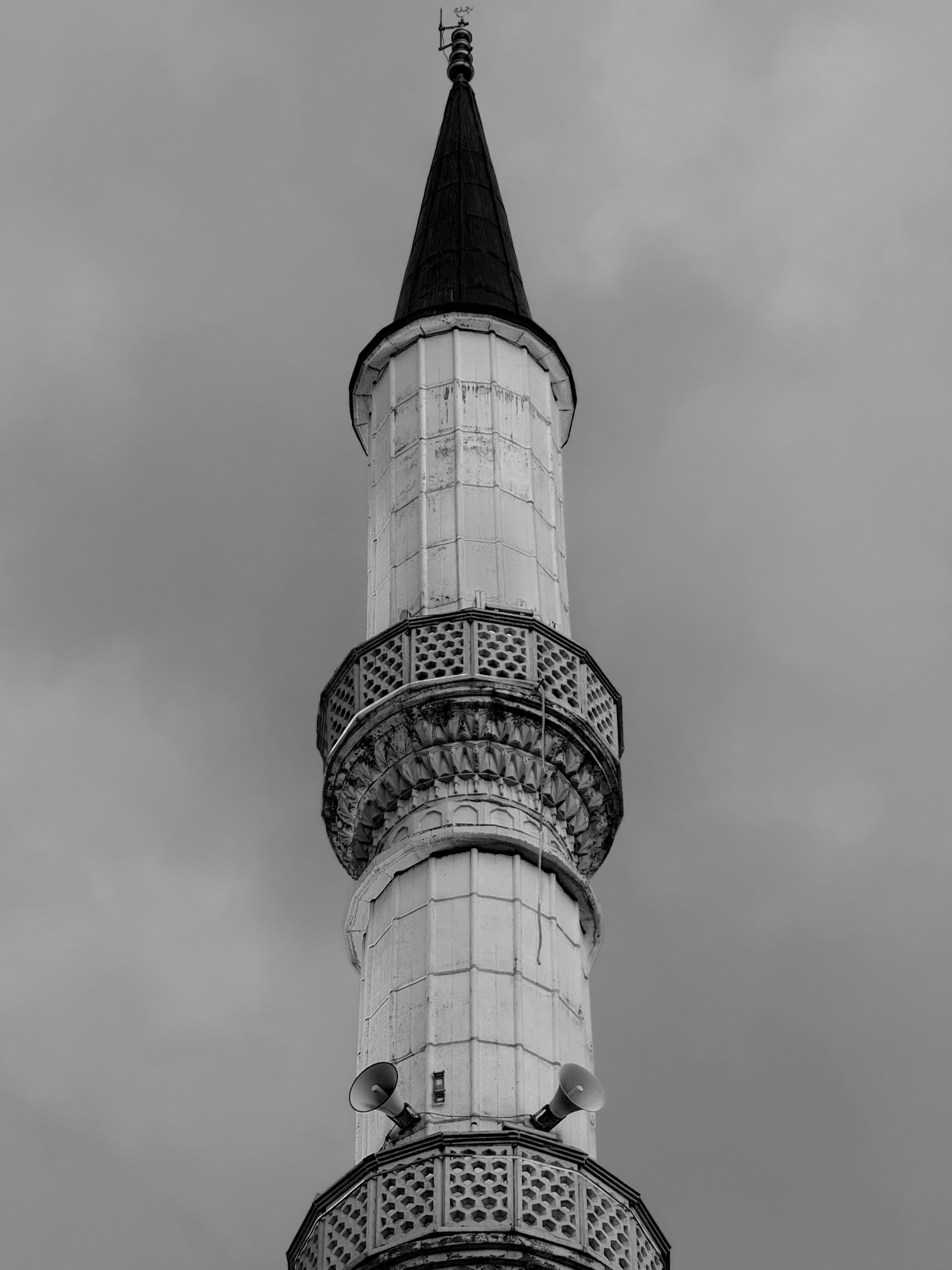 Moonlit Minaret: A Tall Silhouette Against a Stormy Sky