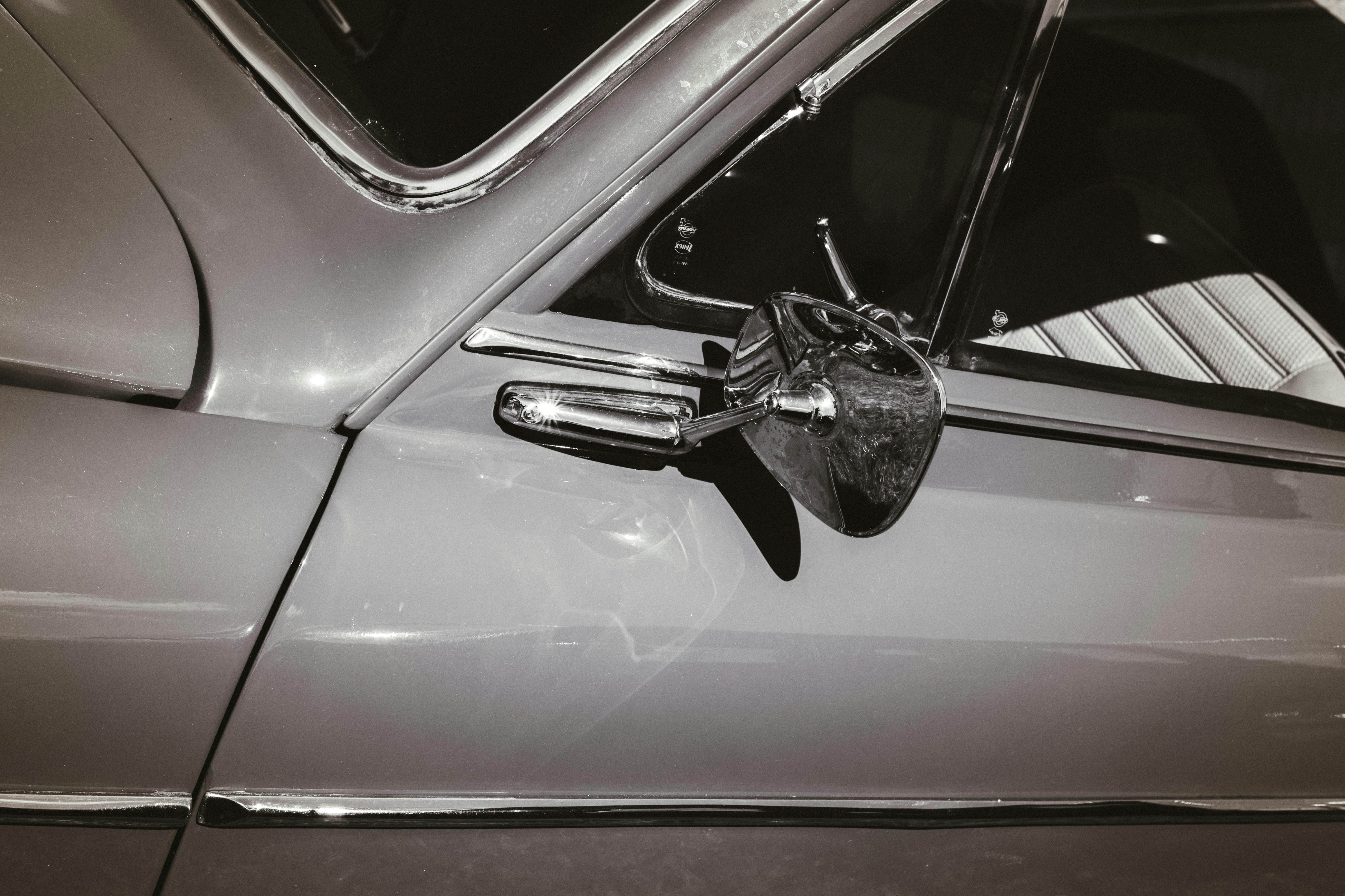 Chrome Mirror Echo: A Classic Car Door in Soft Night Light