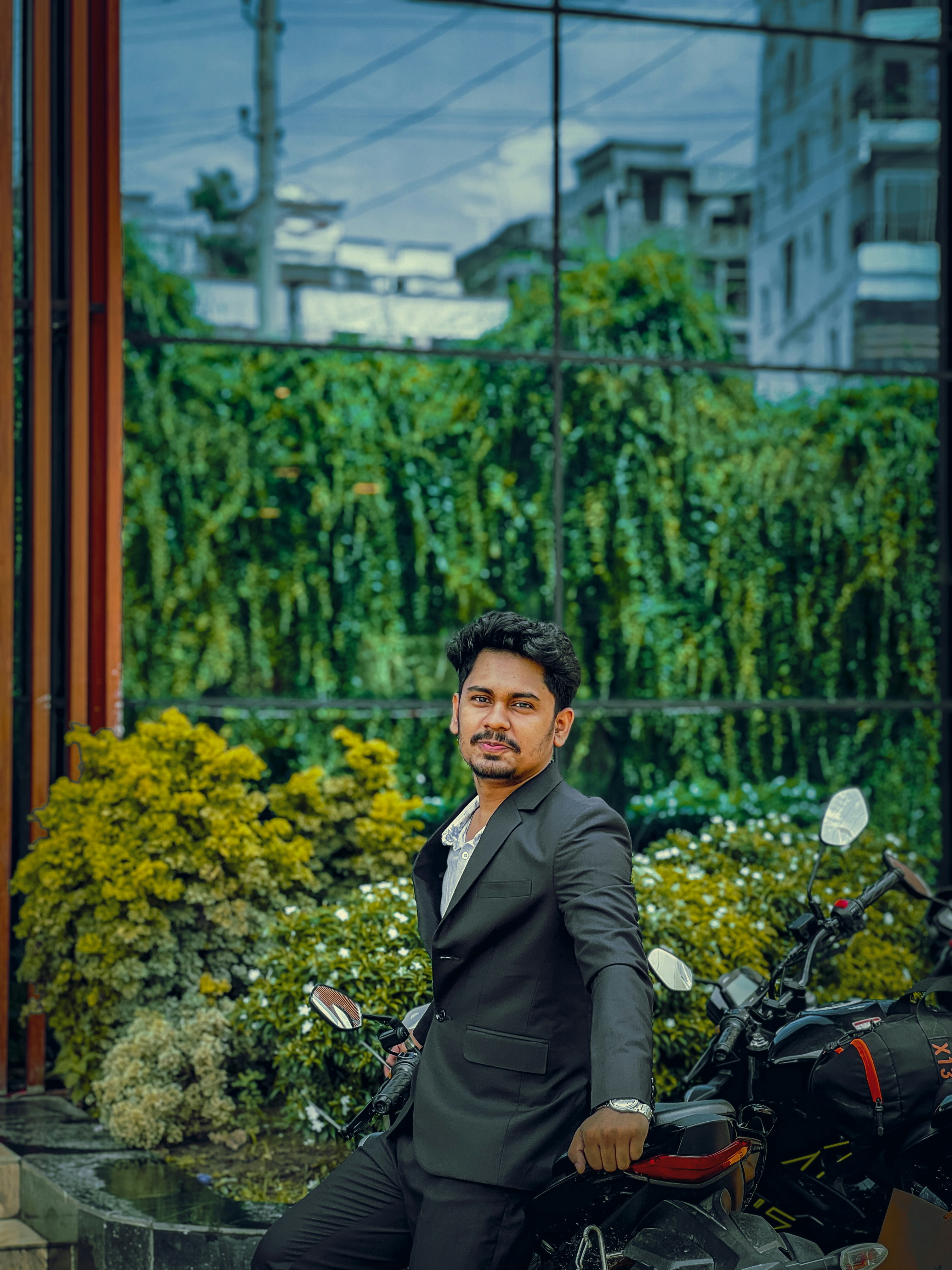 A Confident Pose by the Green Wall