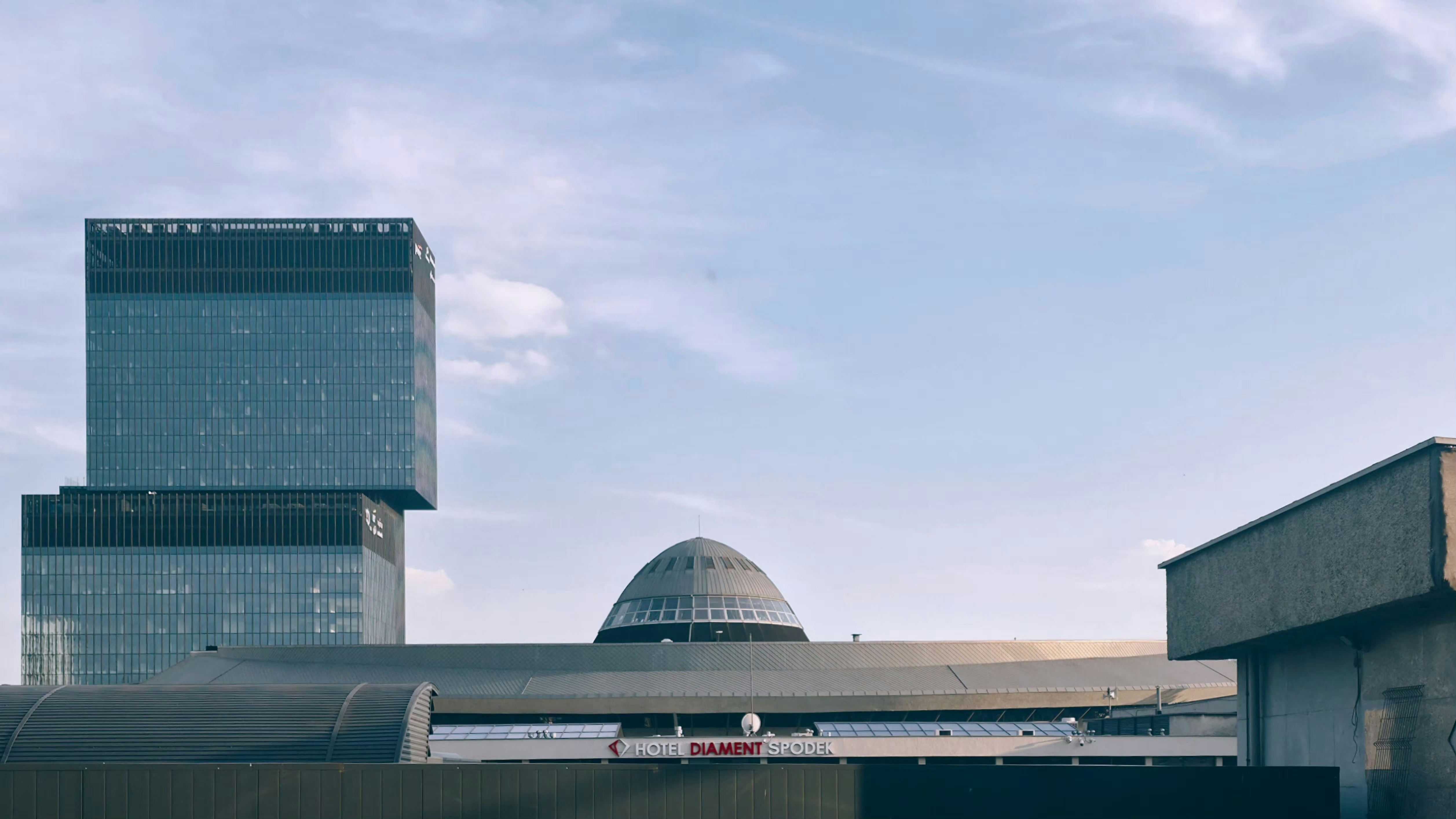 Skyline Convergence: Glass Towers and a Dome Amid the Sunset