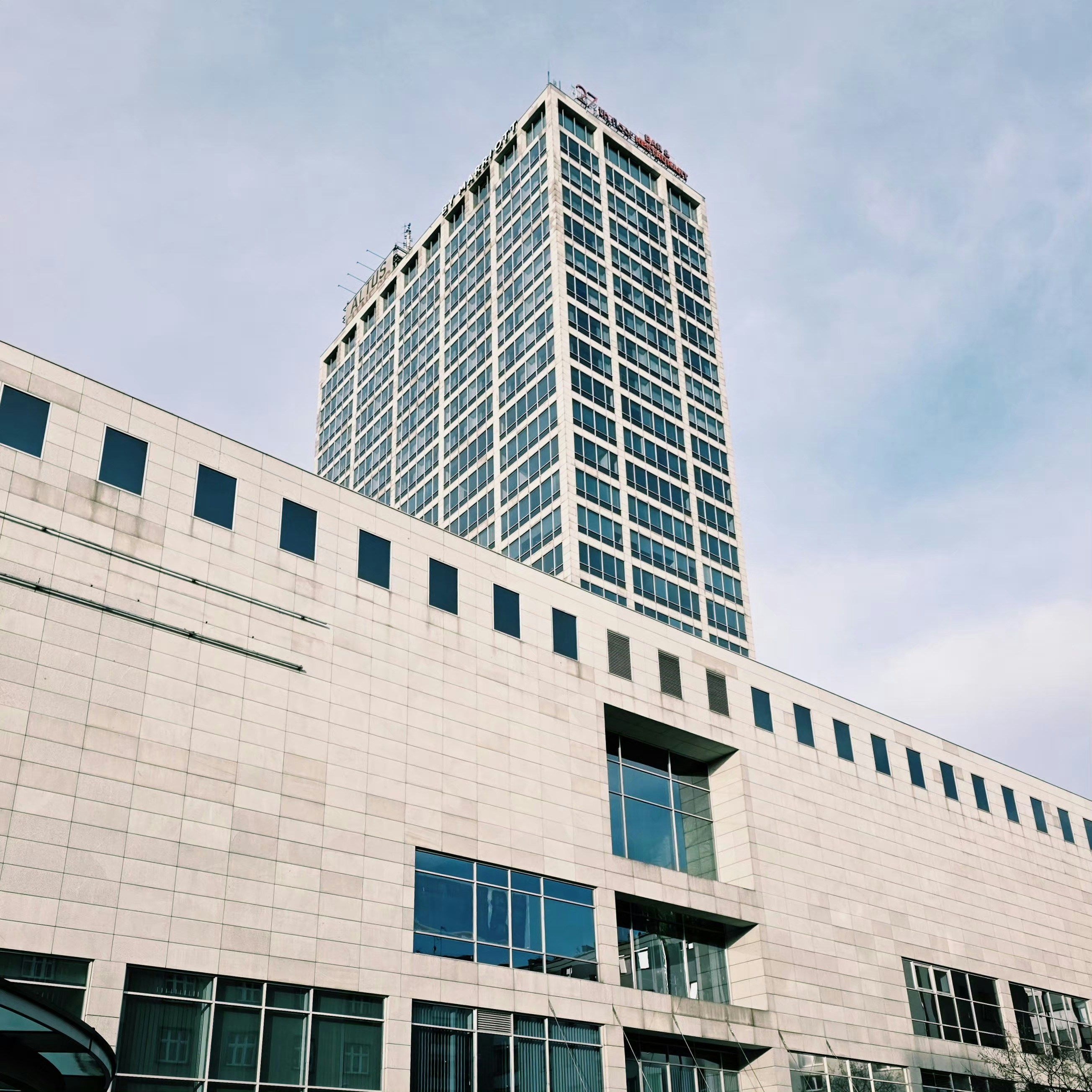 Skyward Facade: A Tower Reaching Above a Modern Terrace