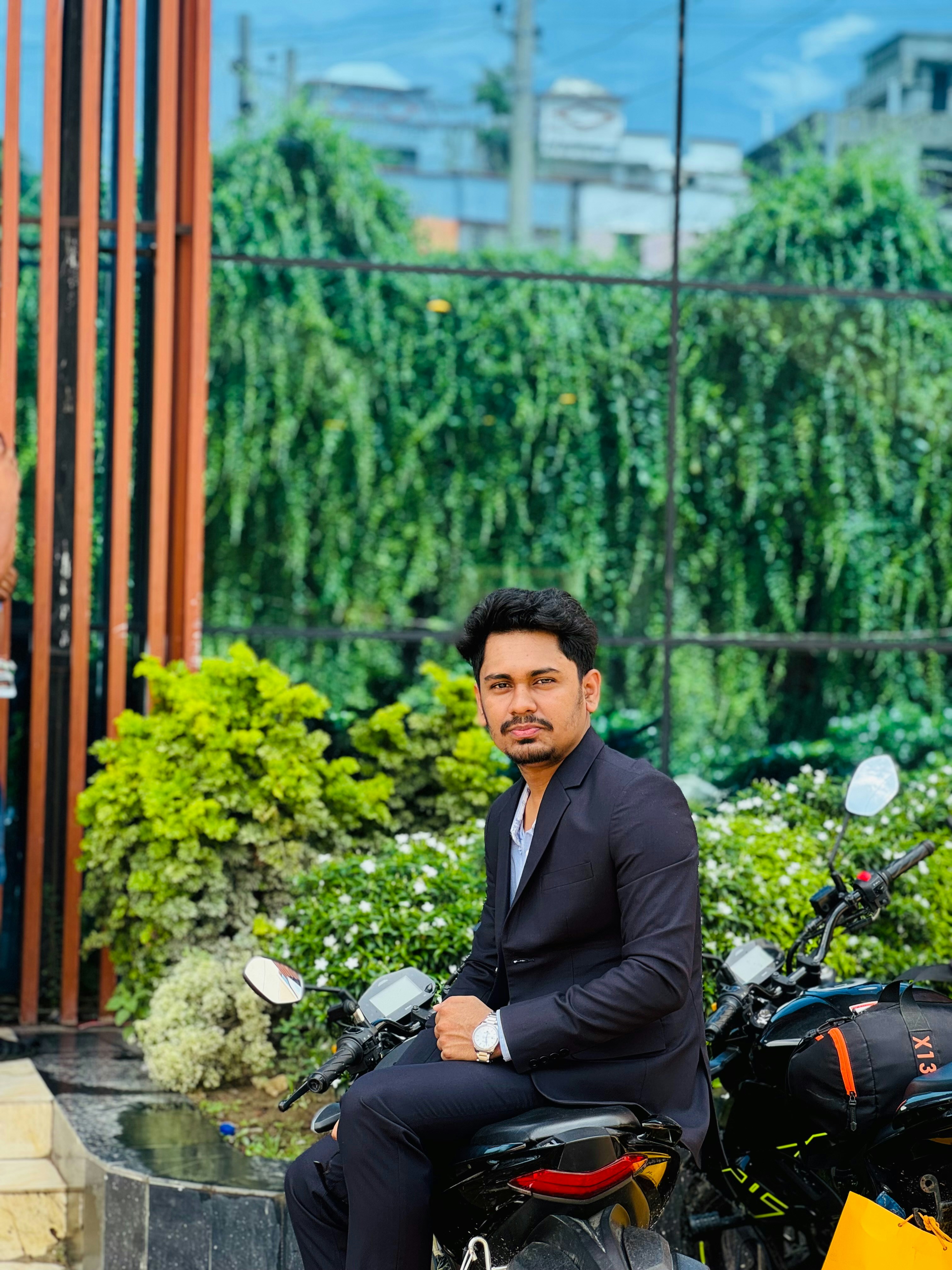 Elegance on Schedule: A Closer Look at the Suited Presenter by the Parked Bikes
