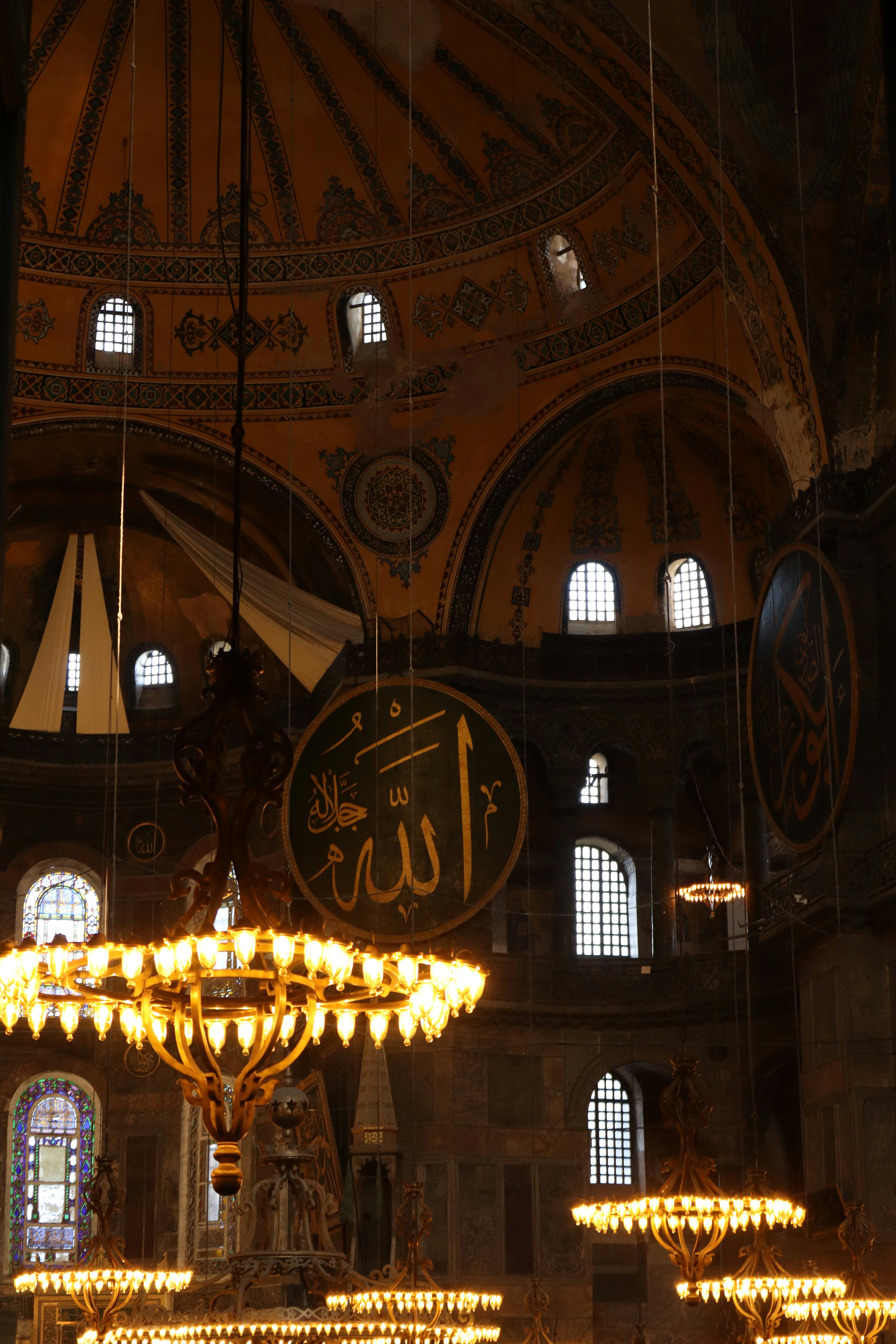 Golden Chandeliers in a Sacred Dome