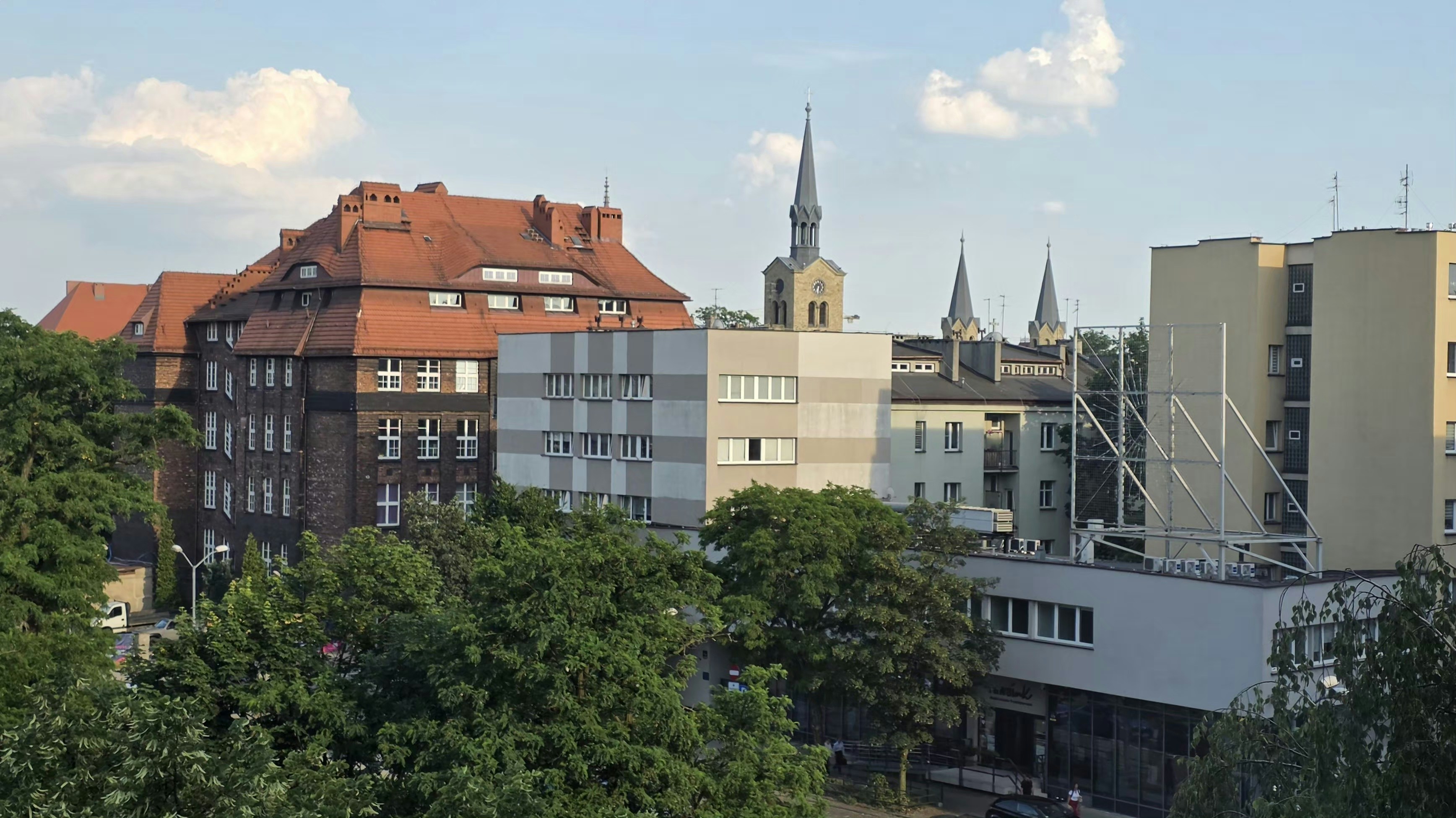 Sunlit Rooftops and Spires Over a Quiet City Block