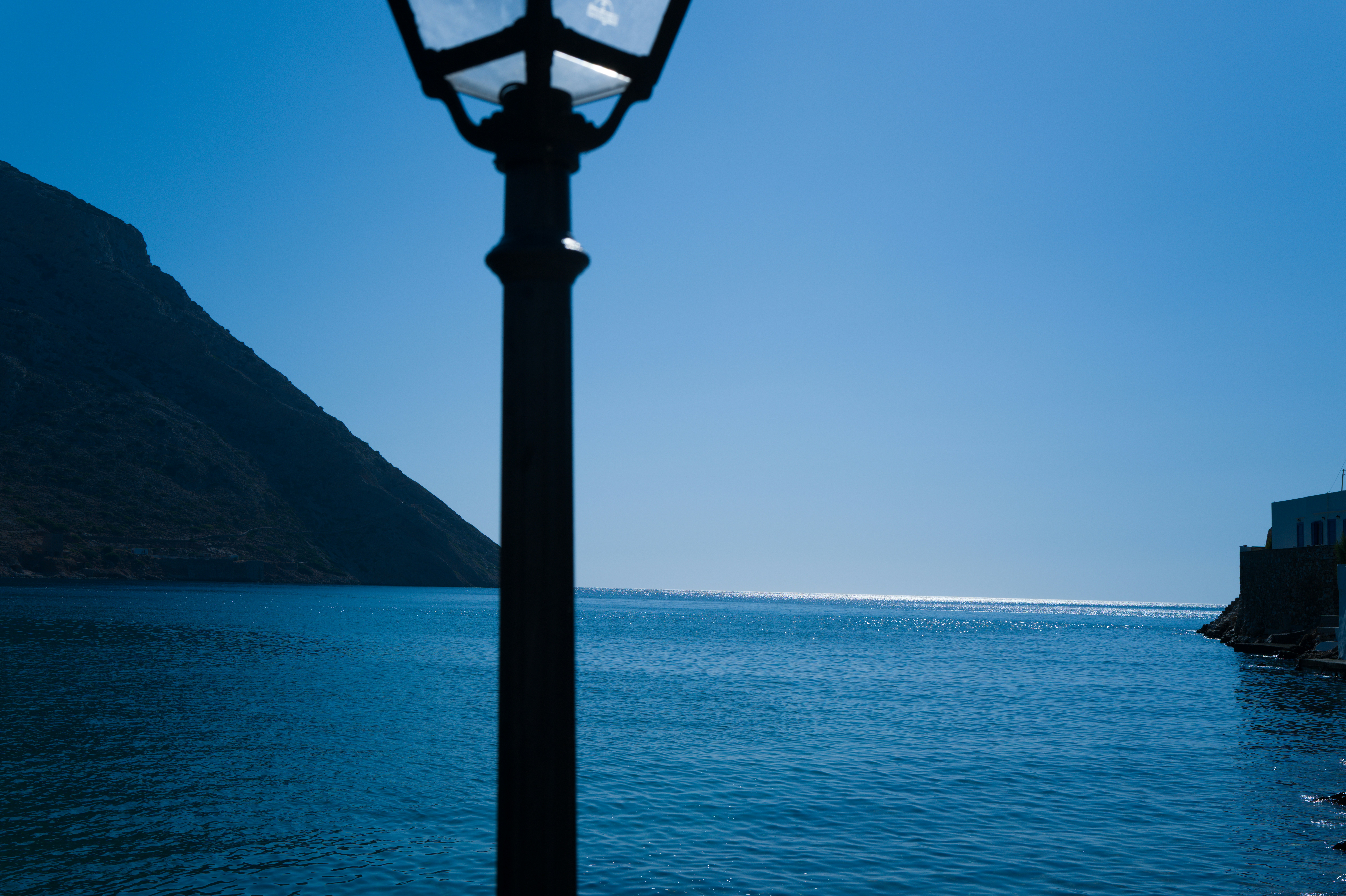 Harbor Lantern at Dusk: A Quiet Sea Under a Silent Pillar