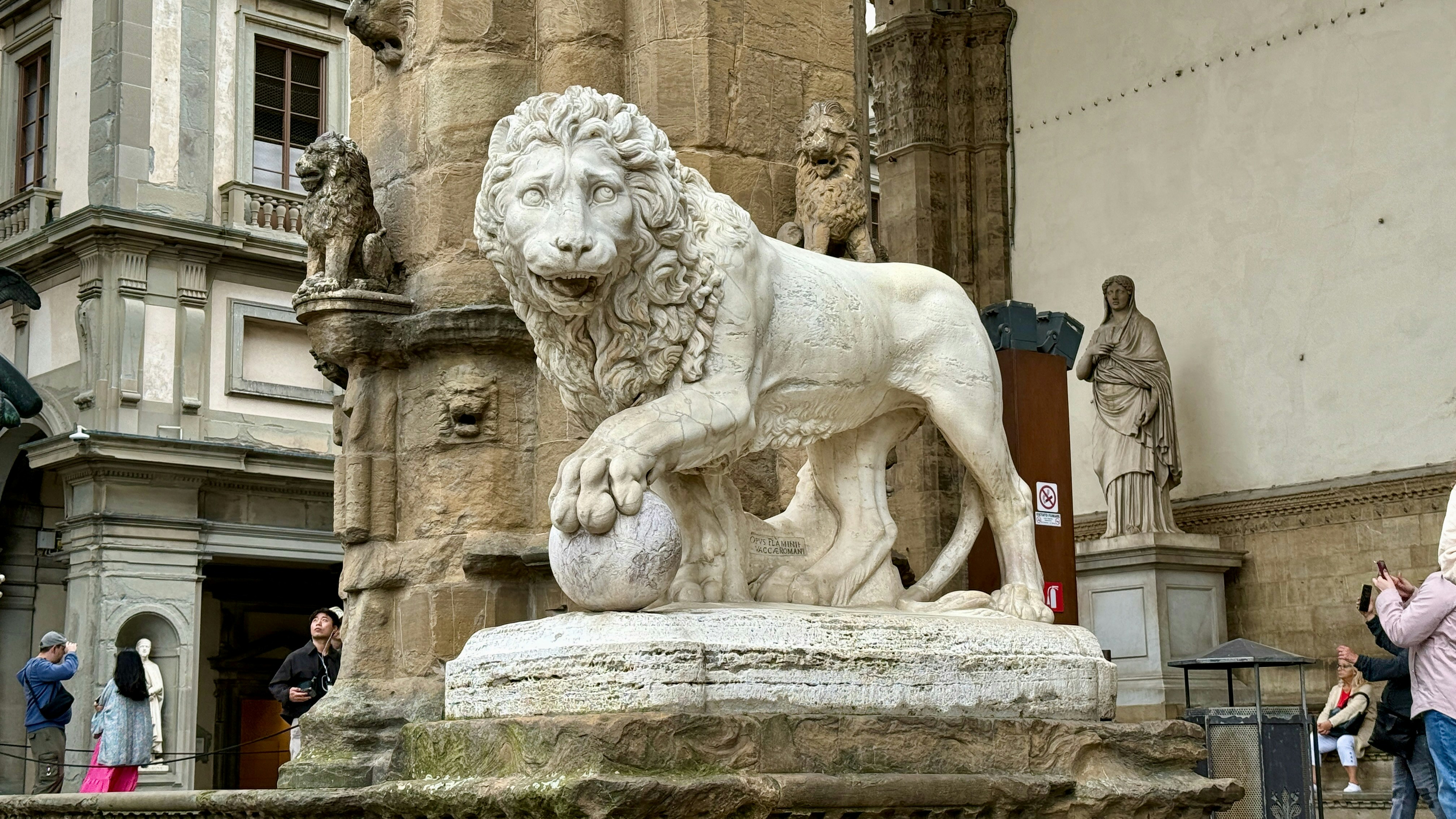 Stone Guardian: A Grand Lion Statue Standing at a Historic Portal
