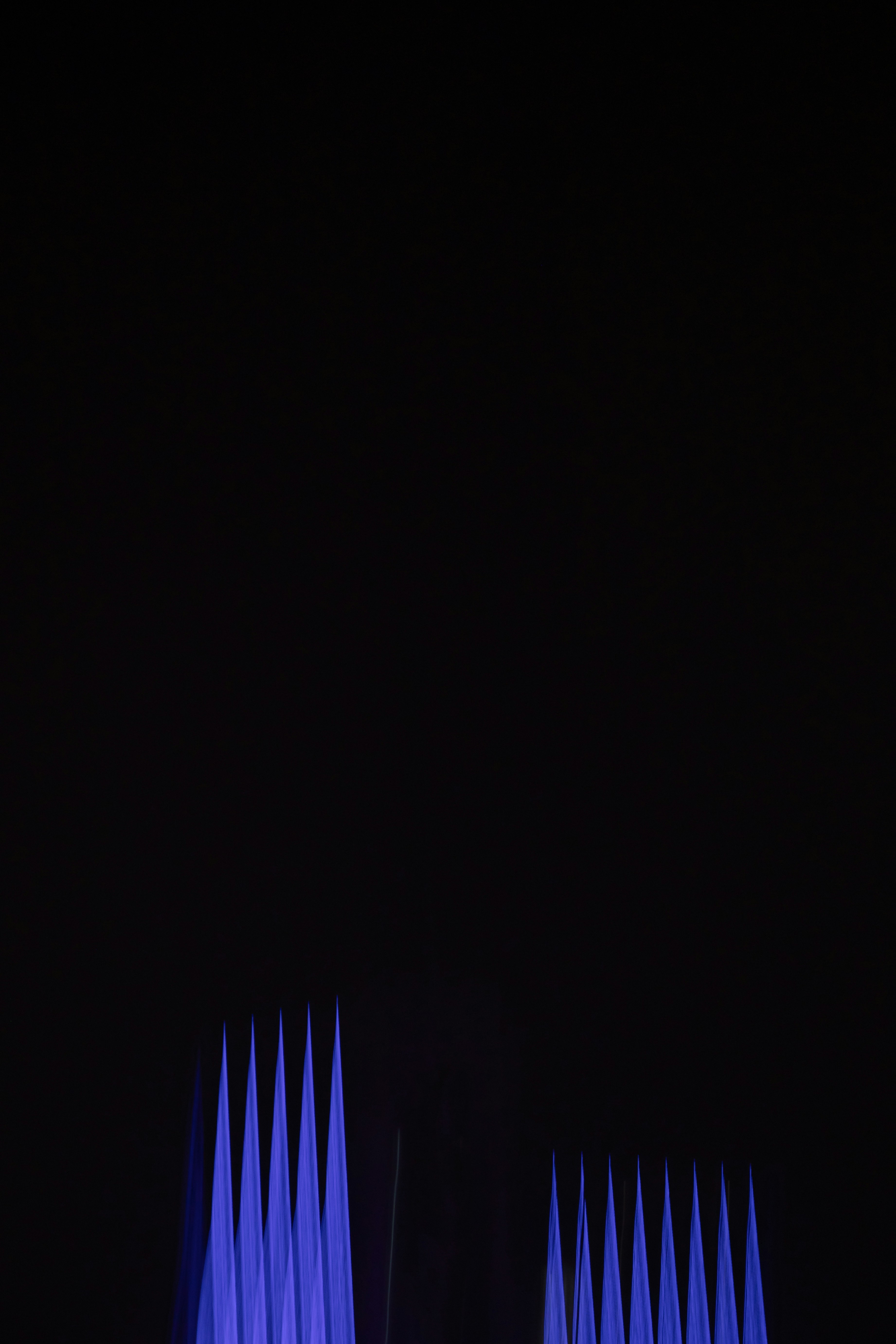Blue Neon Peaks in a Dark Sky